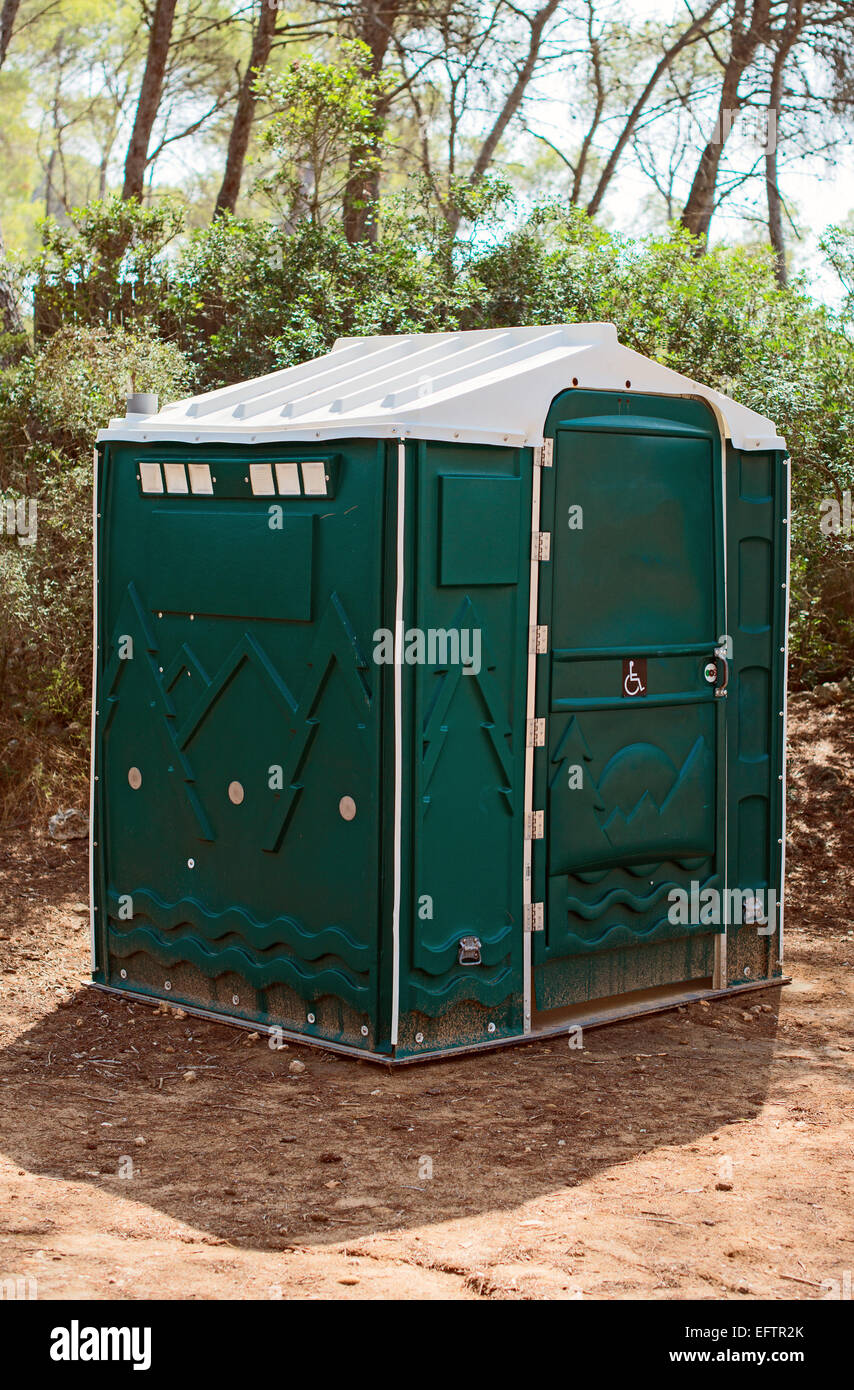 Green plastic toilet booth in the forest Stock Photo - Alamy