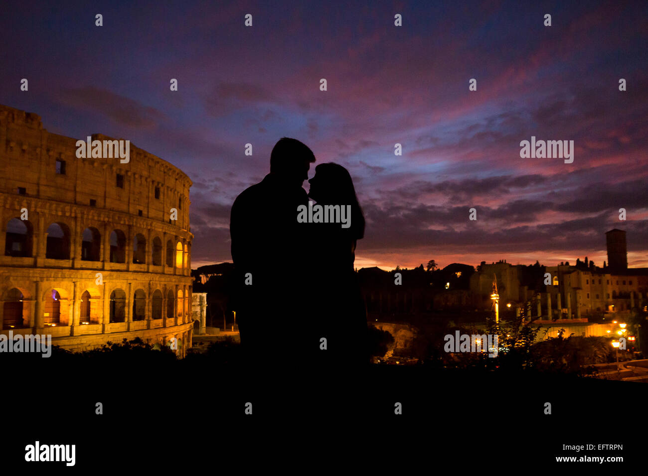 Couple silhouette at sunset. Roman Colosseum. Rome, Italy Stock Photo ...