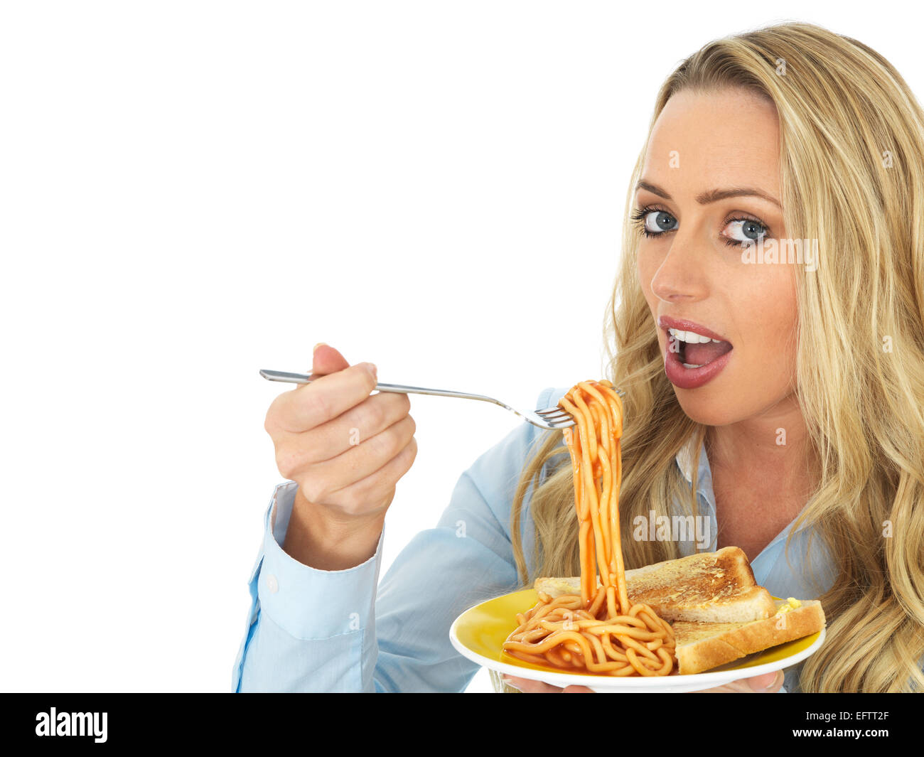 Attractive Young Woman Eating Spaghetti on Toast Stock Photo - Alamy