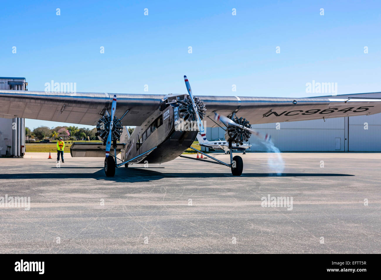 Passengers on board start the three Wright J-6-9 Whirlwind nine ...