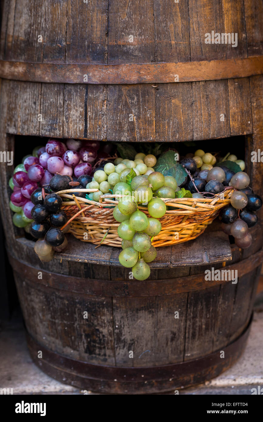 Wide assortment of grapes fresh picked and contained in a wooden barrel ...