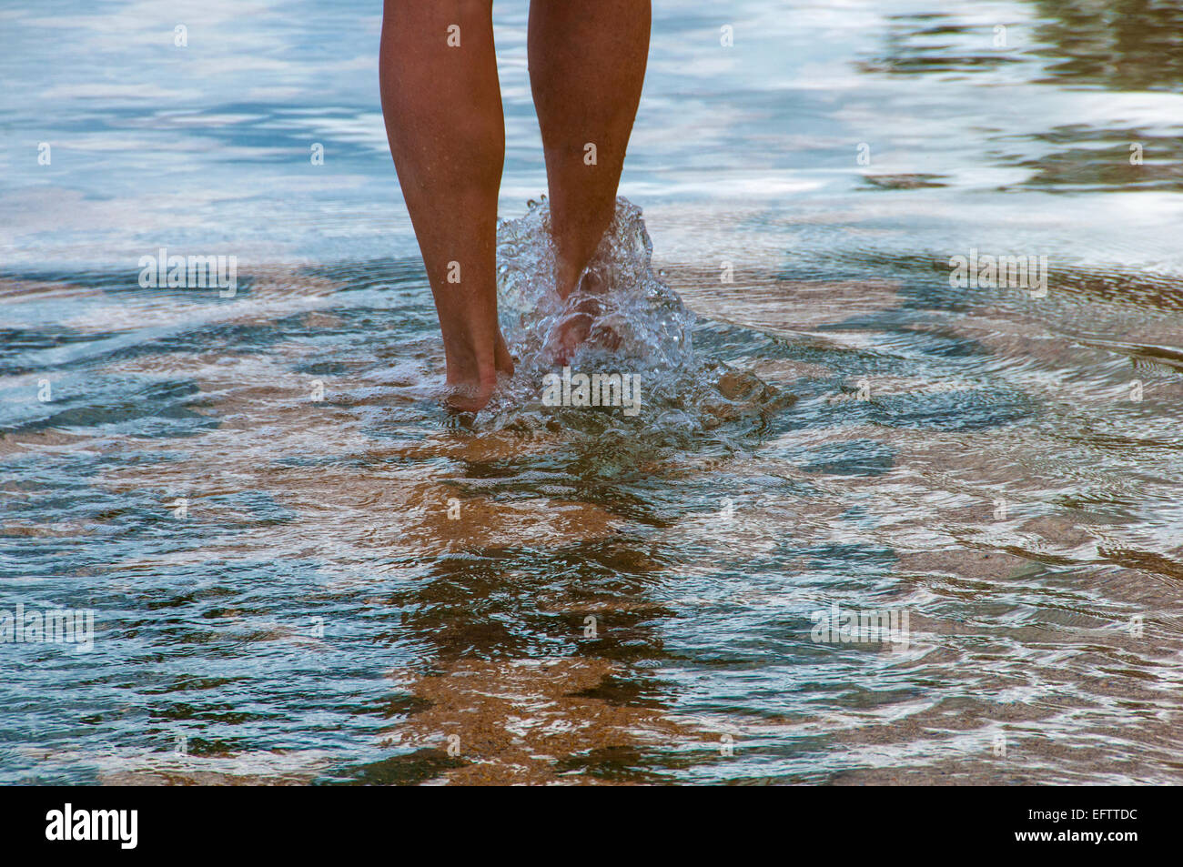 Wading on a tropical beach Stock Photo - Alamy