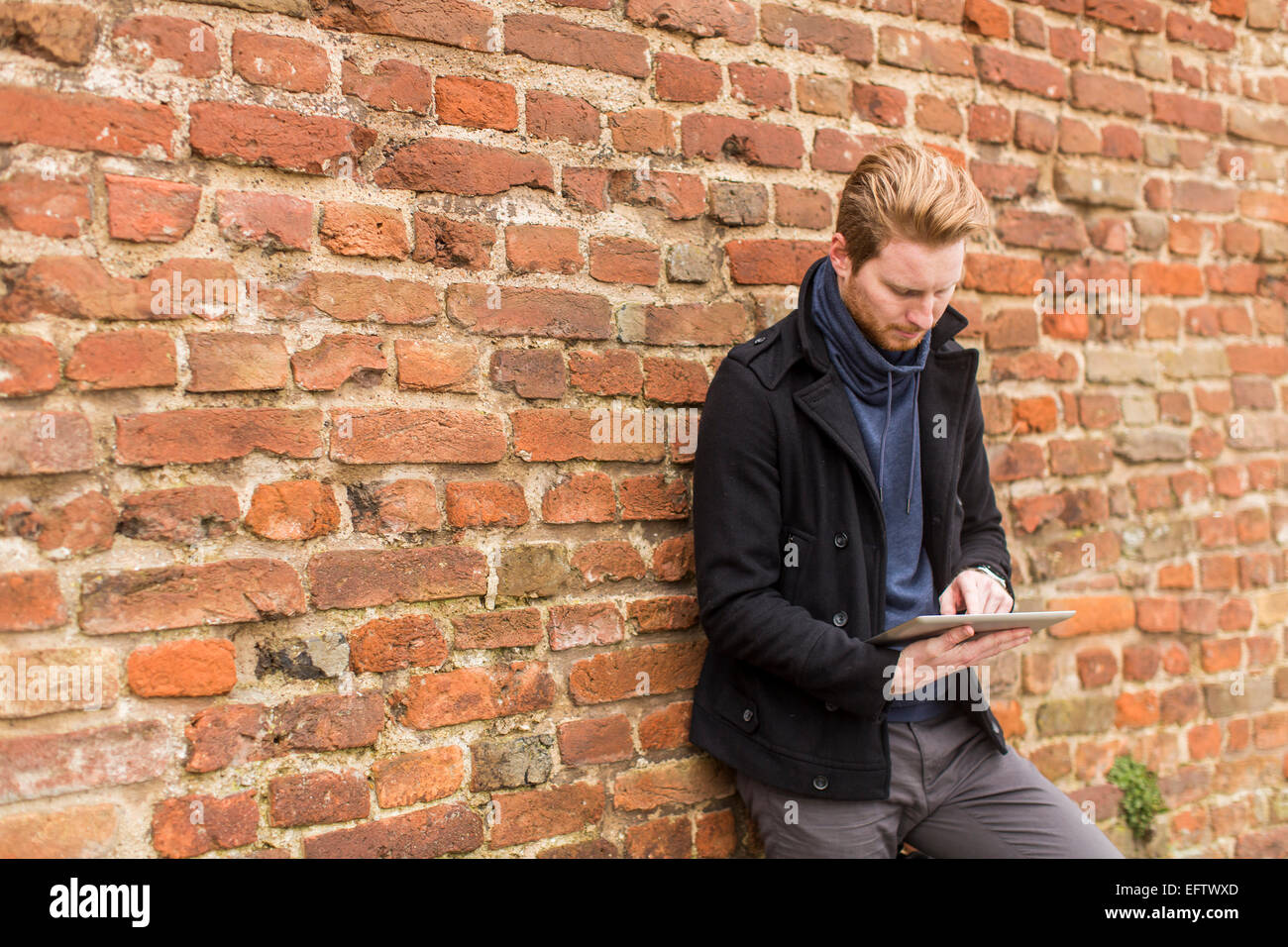 Red brick wall man standing hi-res stock photography and images - Alamy