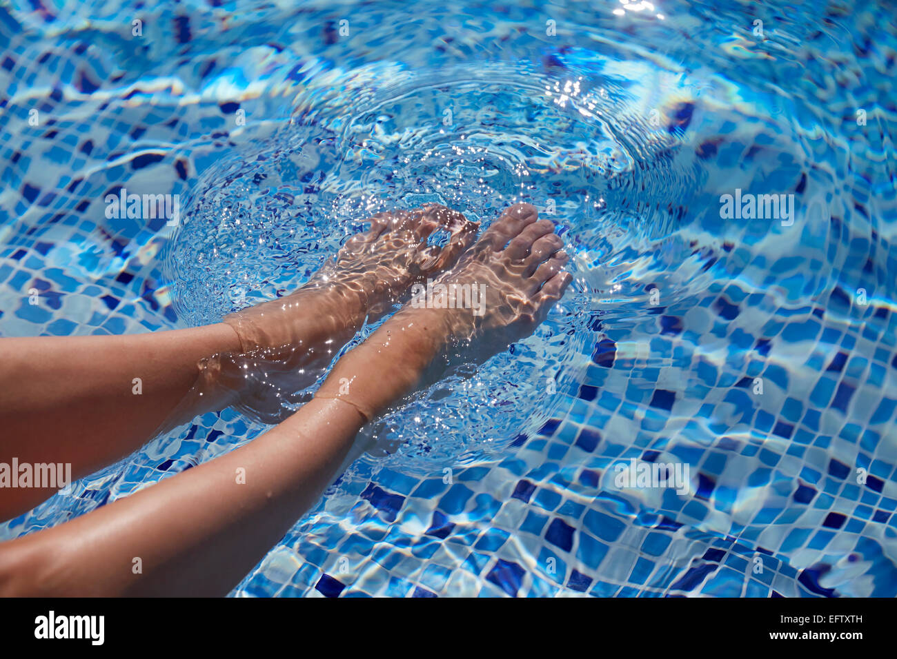 Splashing feet in the swimming pool Stock Photo - Alamy