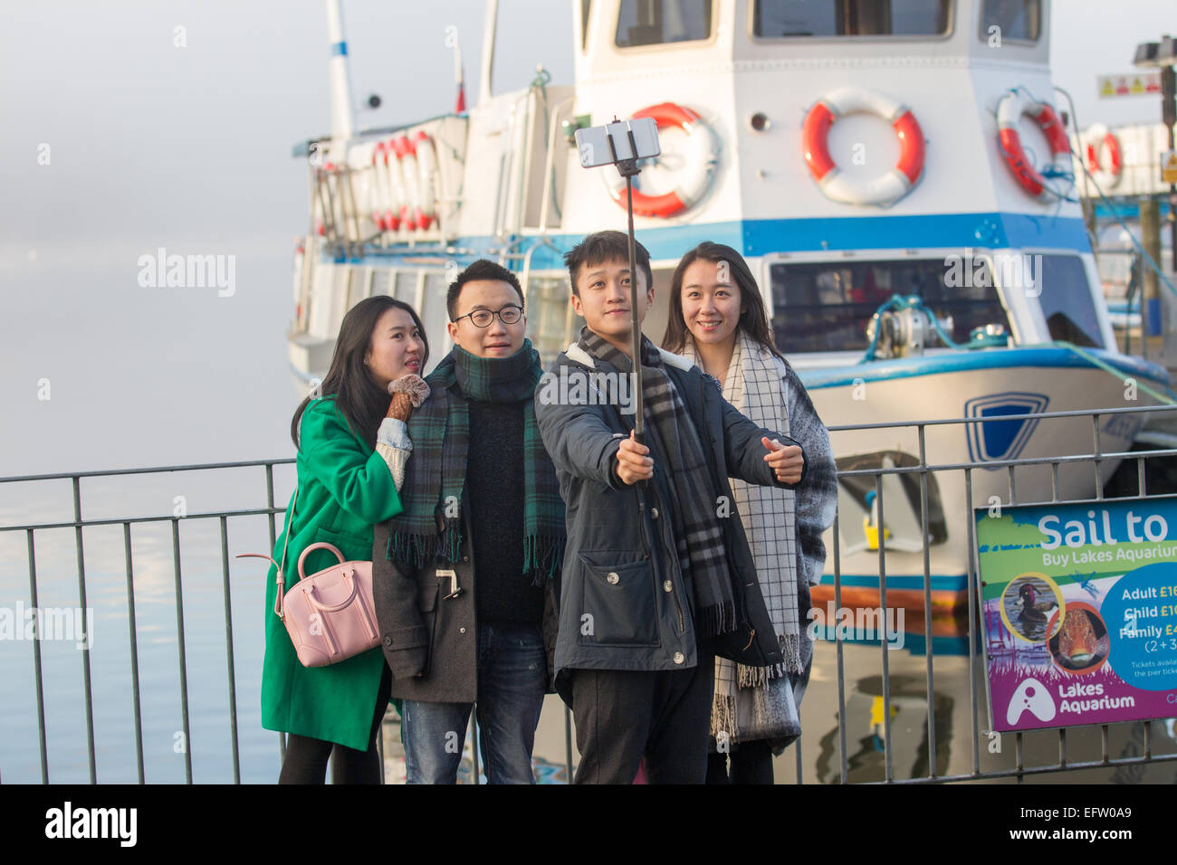 Take selfies using selfie sticks hi-res stock photography and images ...