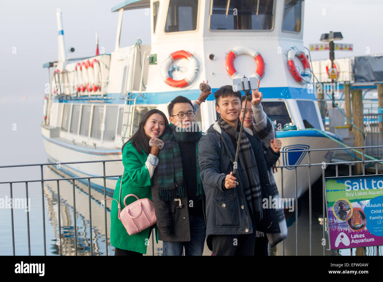 Take selfies using selfie sticks hi-res stock photography and images ...