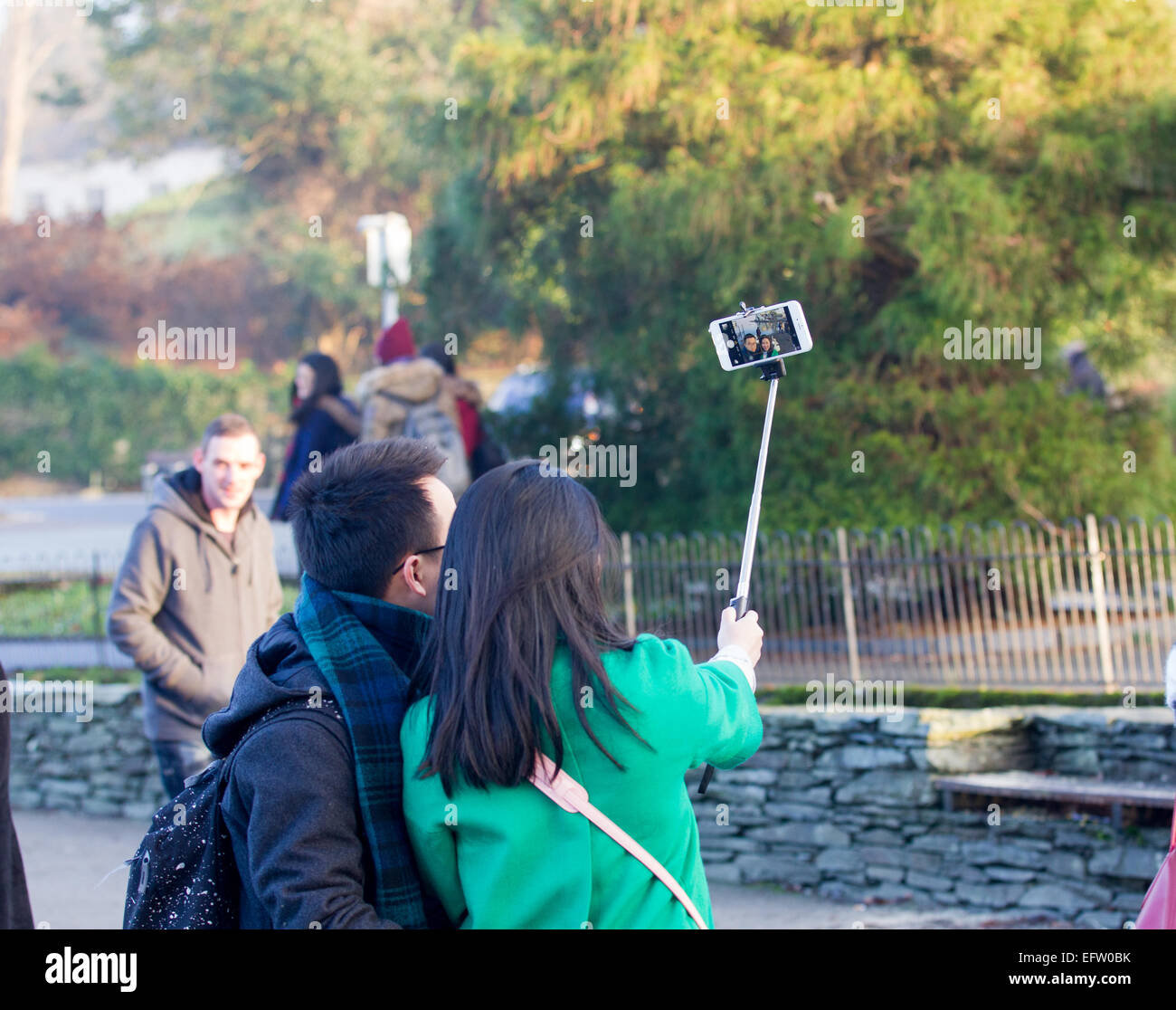 Take selfies using selfie sticks hi-res stock photography and images ...