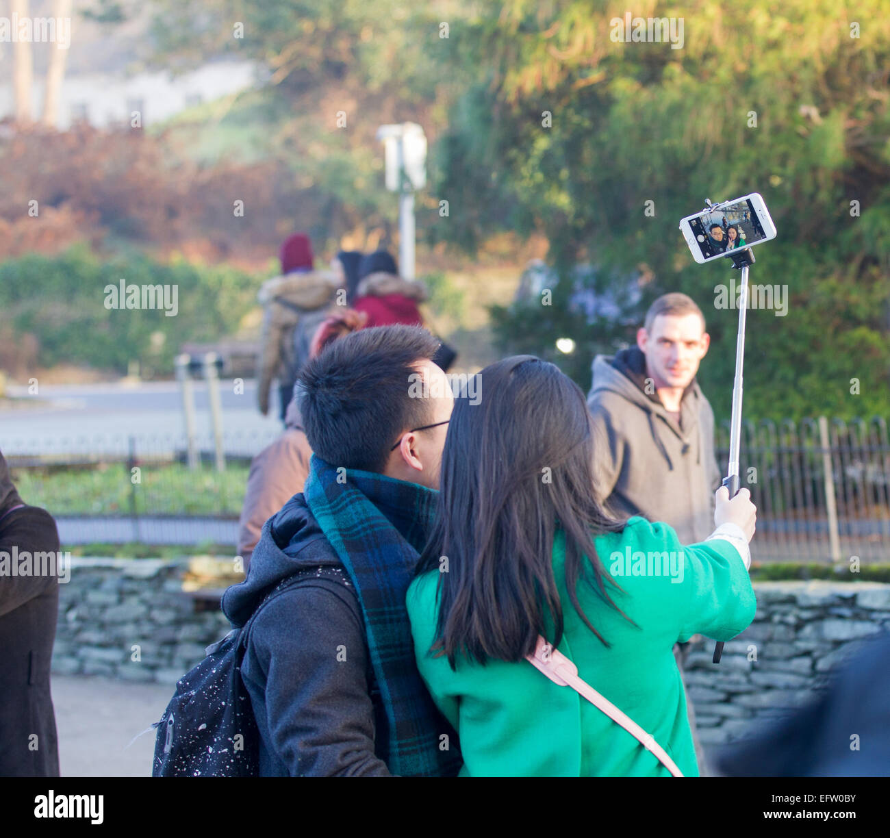 Tourists using mobile smartphone Iphone selfie - selfies stick to take ...