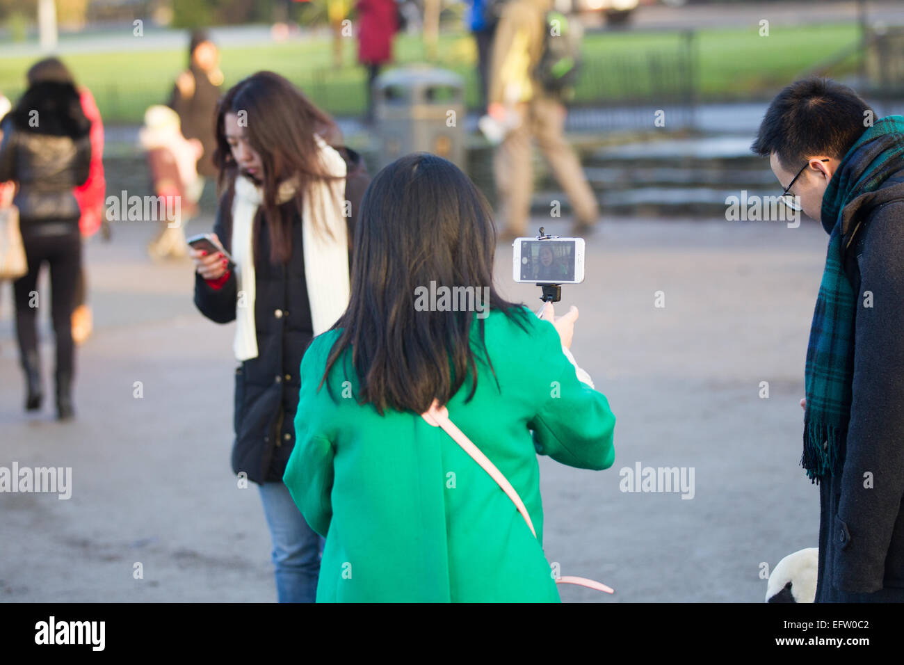 Take selfies using selfie sticks hi-res stock photography and images ...