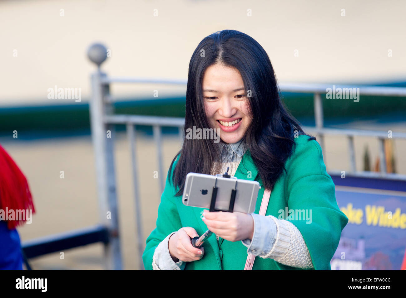 Tourists using mobile smartphone Iphone selfie - selfies stick to take ...