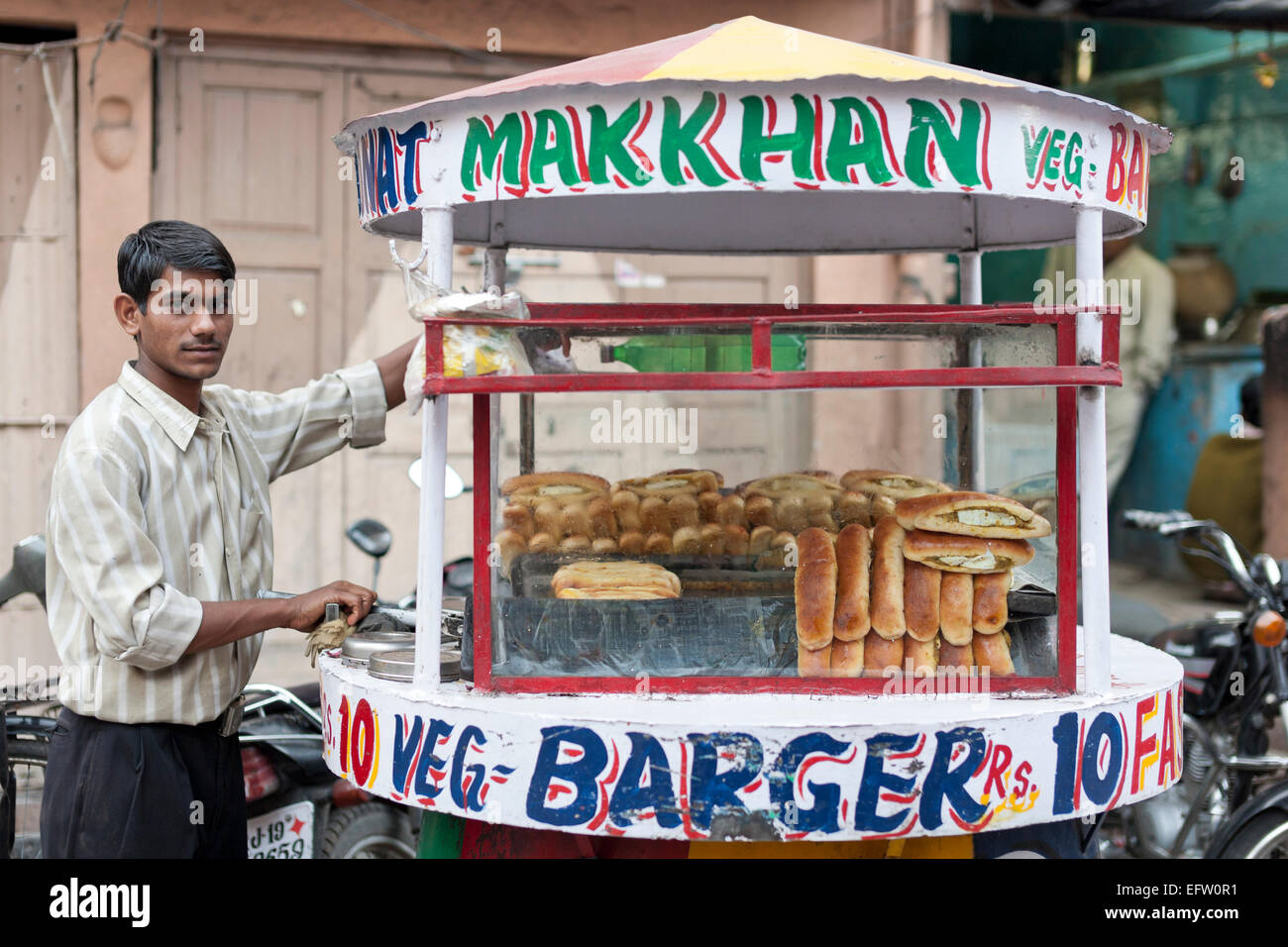 Jodhpur, Rajasthan, India. Young man selling vegetarian burgers from a ...