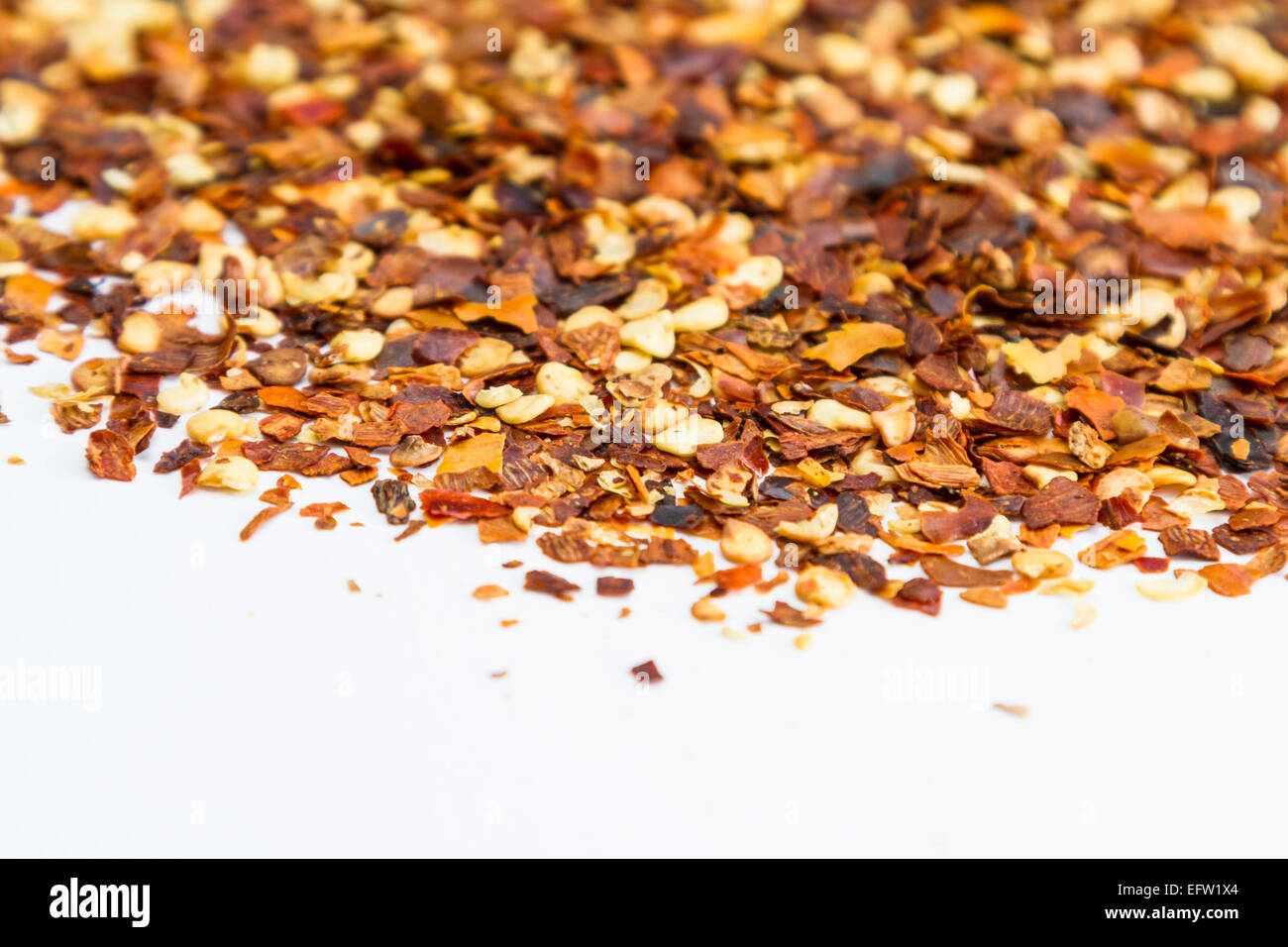 close up of red pepper flakes on a white background Stock Photo - Alamy