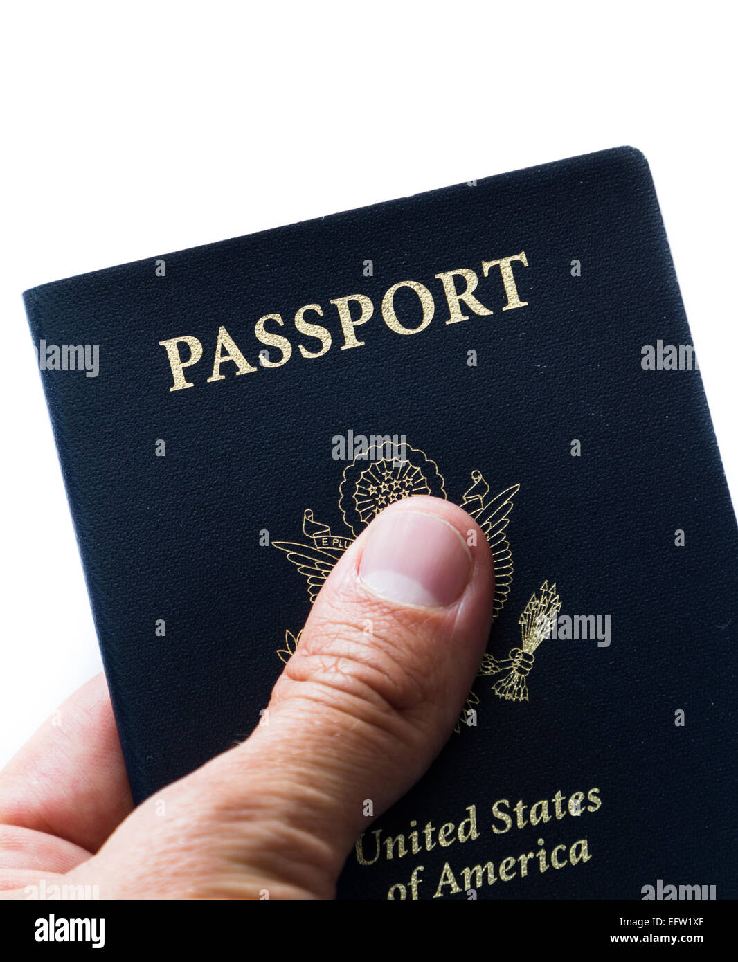 close up of a hand holding an american passport over a white background ...