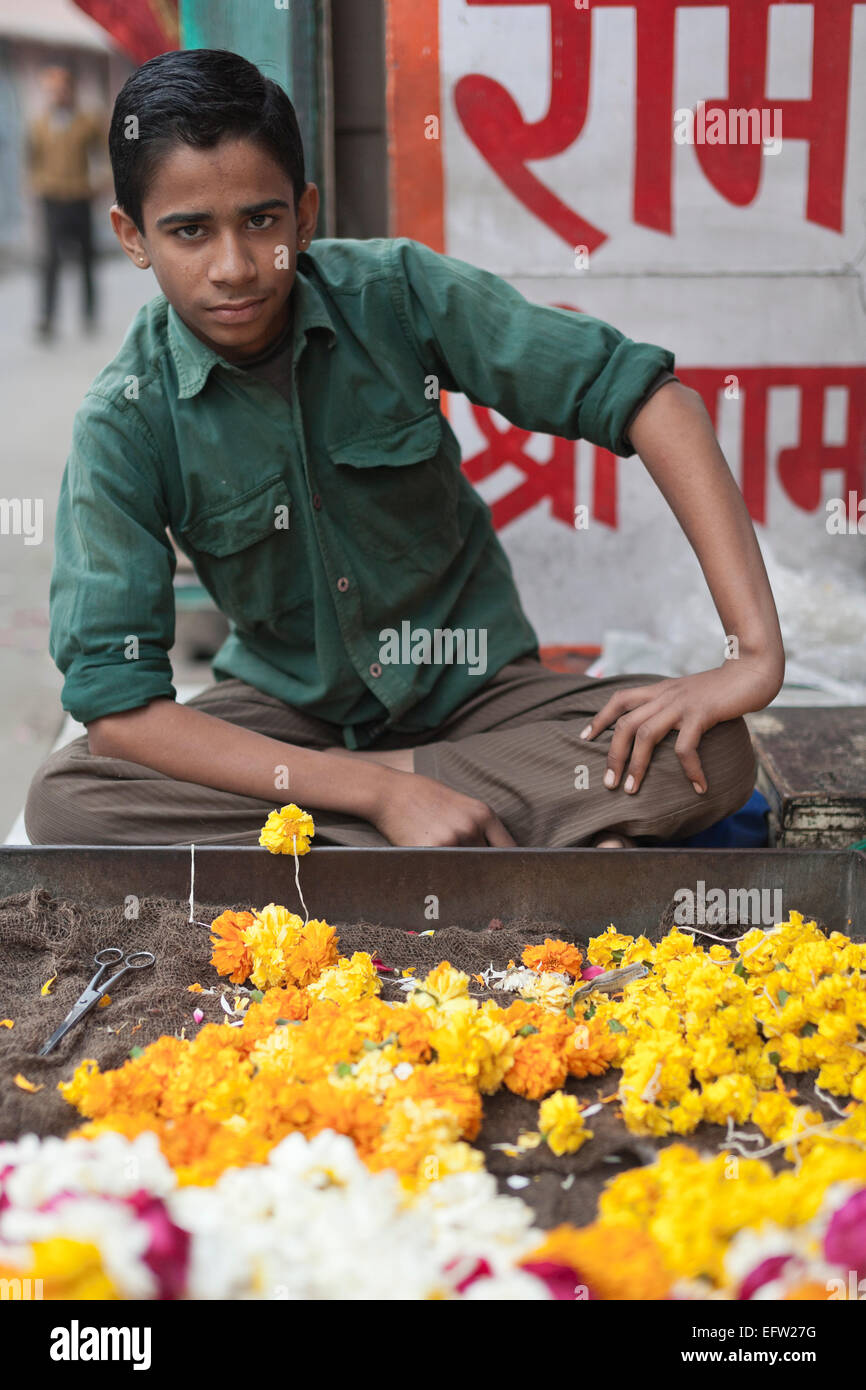 Jodhpur, Rajasthan, India. Teenage boy selling flower garlands from a ...