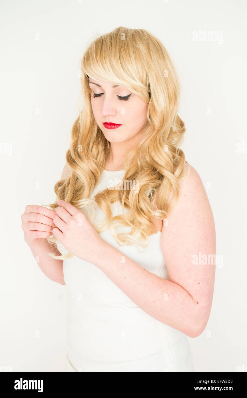 A demure innocent seductive femme fatale type caucasian blond haired ...