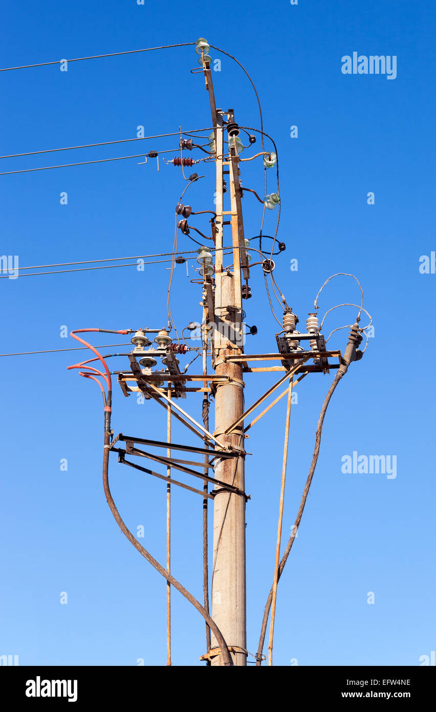 Power line wiring and insulators system over blue sky Stock Photo - Alamy