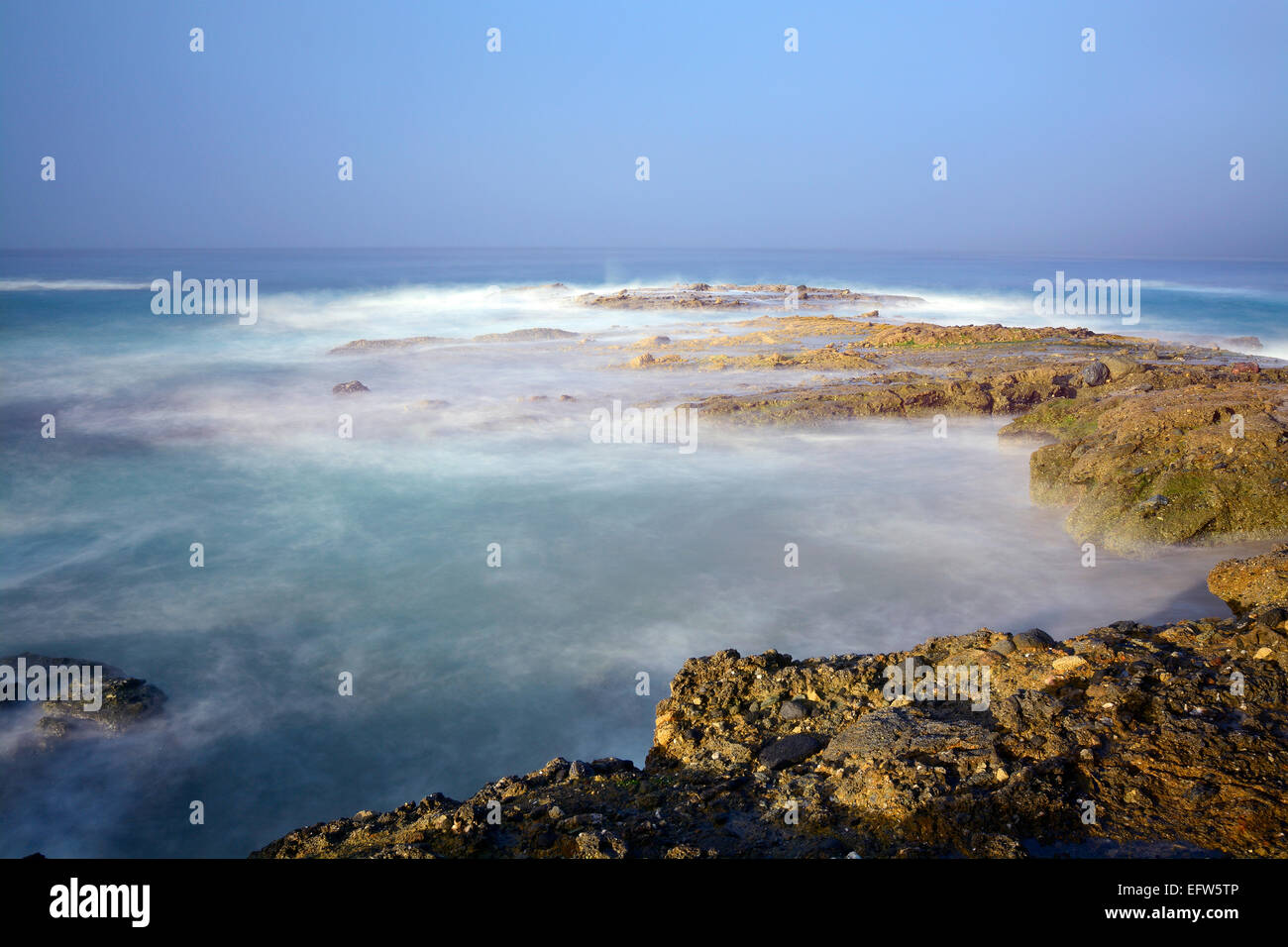An early morning slow motion images of seawater rushing over sharp ...