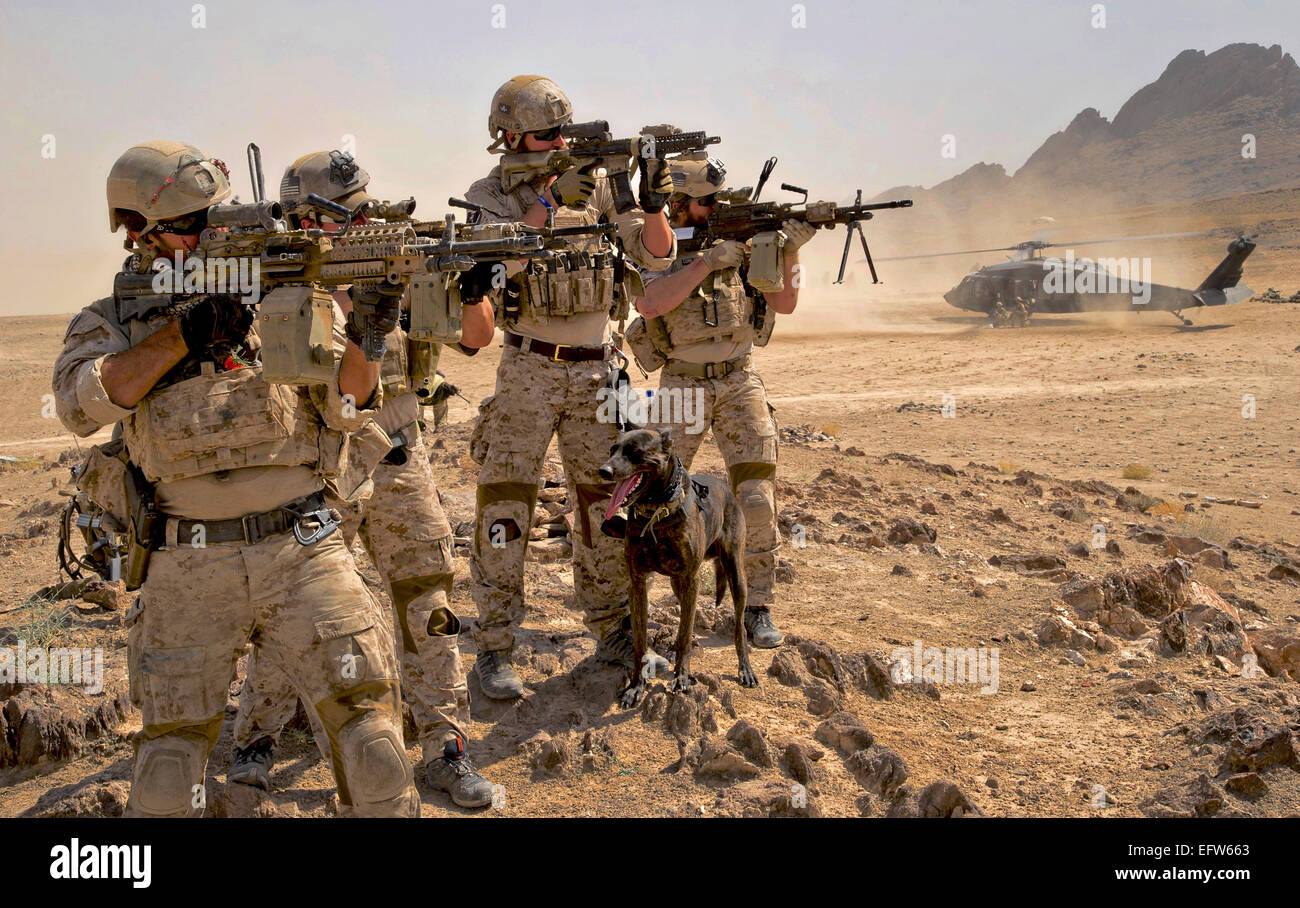 US special force commandos provide security as troops off-load from a ...