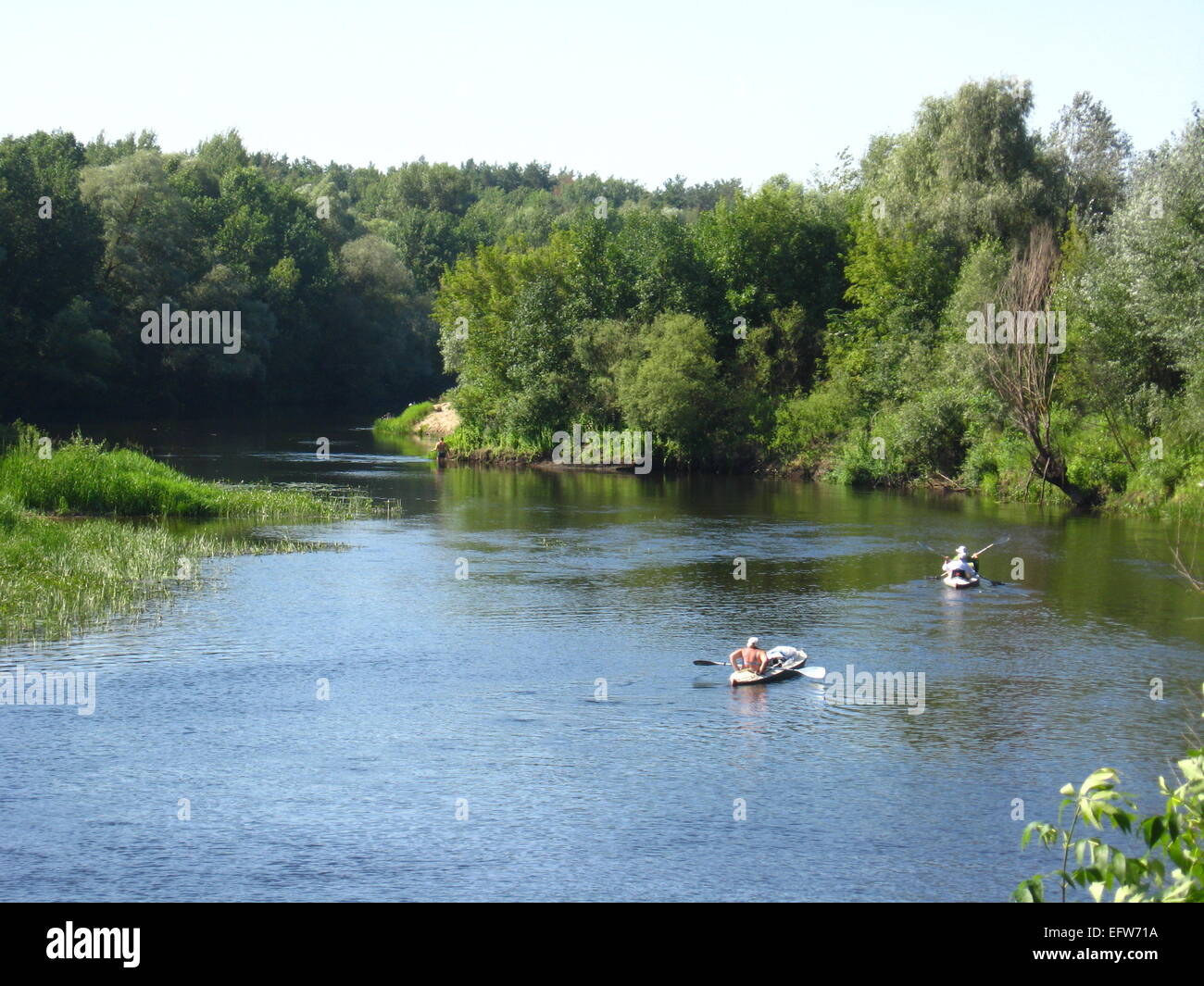 beautiful landscape with river and canoe with people on it Stock Photo ...