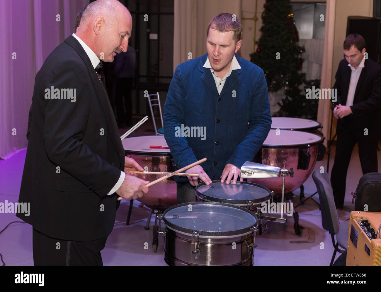 The guitarist and drummer near the musical instruments to and during a ...
