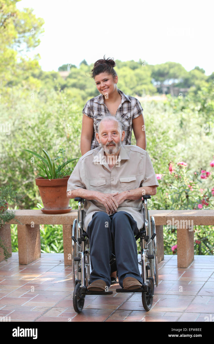 senior man being pushed in wheelchair Stock Photo - Alamy