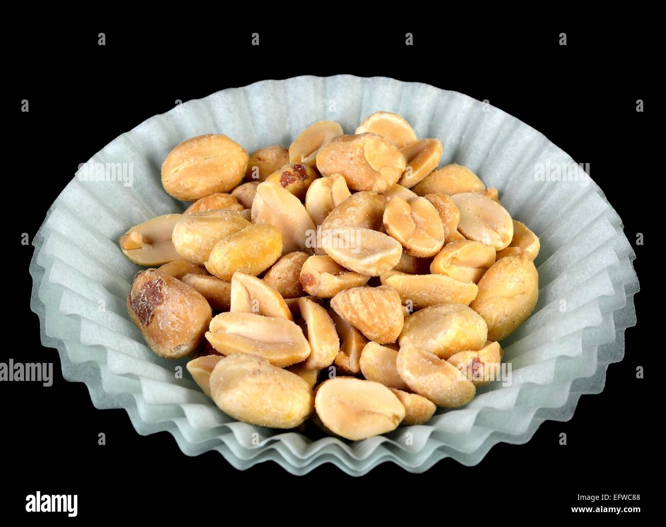 Peanuts in a blue paper dish on a black background Stock Photo - Alamy