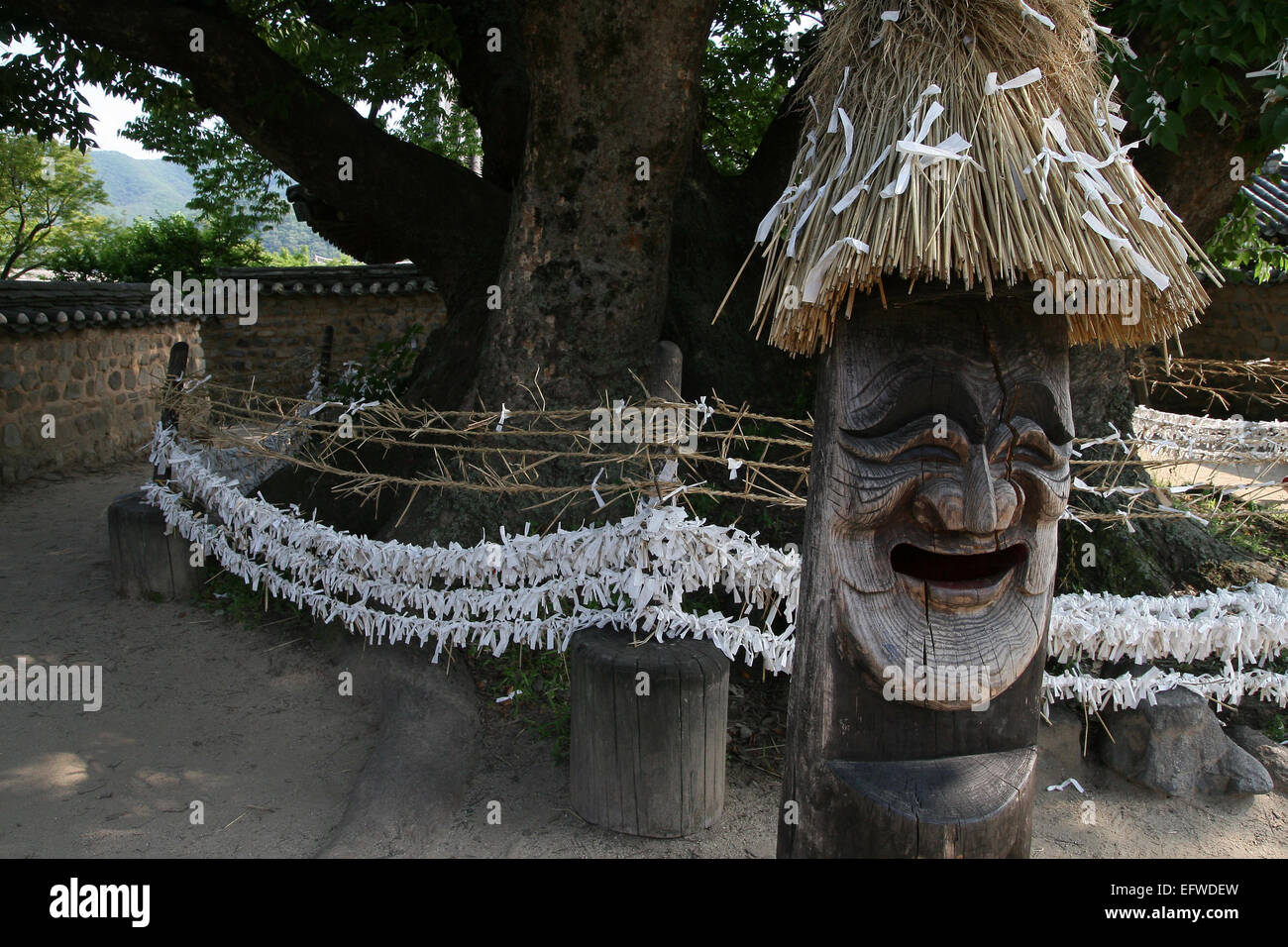 A special wishing tree with a wooden mask with visitors wishes at Hahoe ...