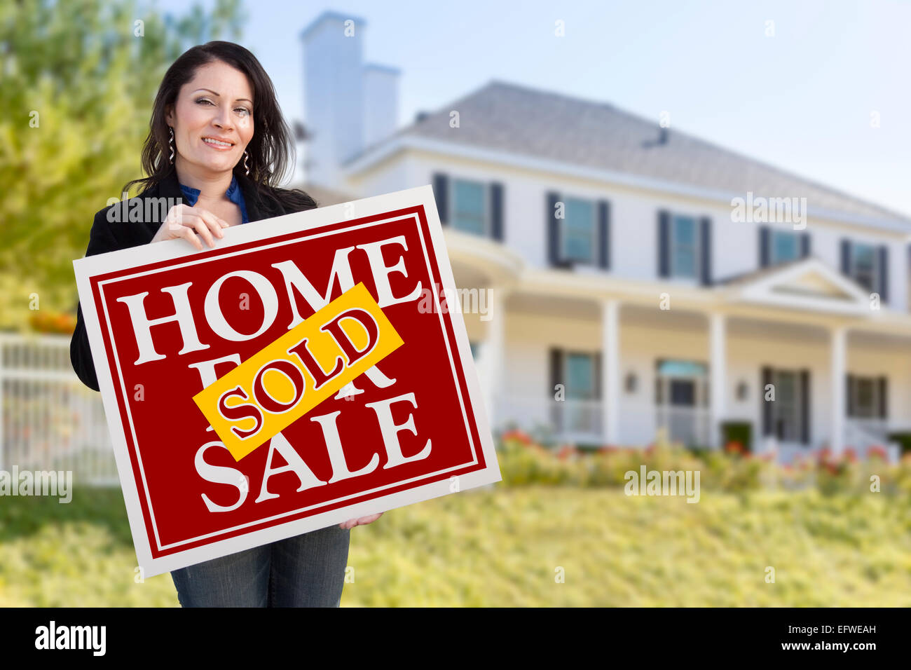 Female realtor holding sold sign hi-res stock photography and images ...