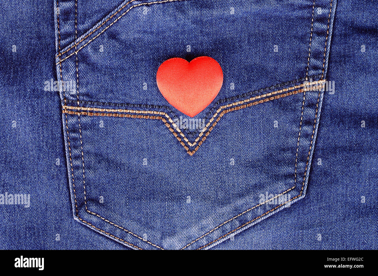 Read heart shape on blue jeans texture Stock Photo - Alamy