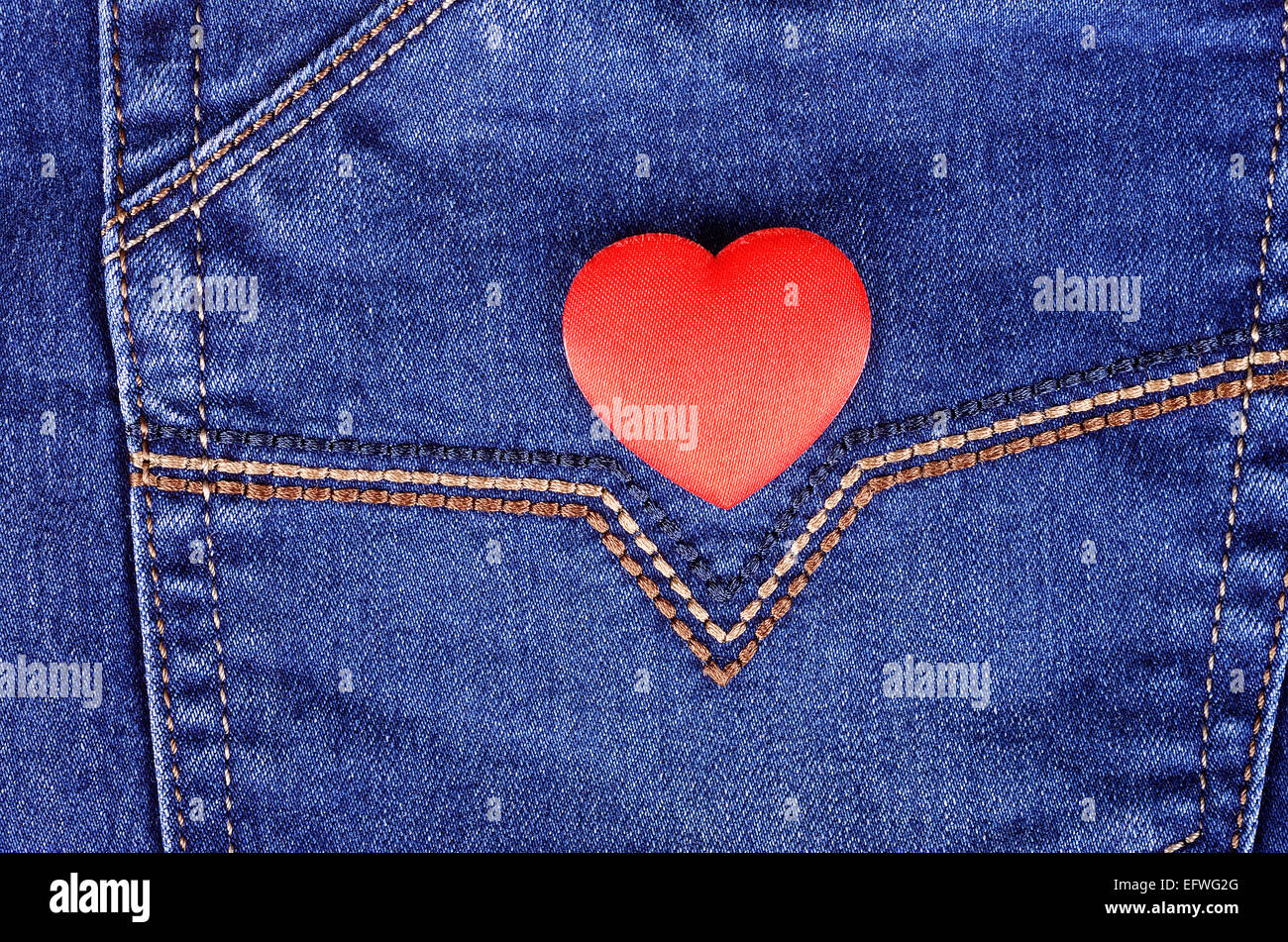 Read heart shape on blue jeans texture Stock Photo - Alamy