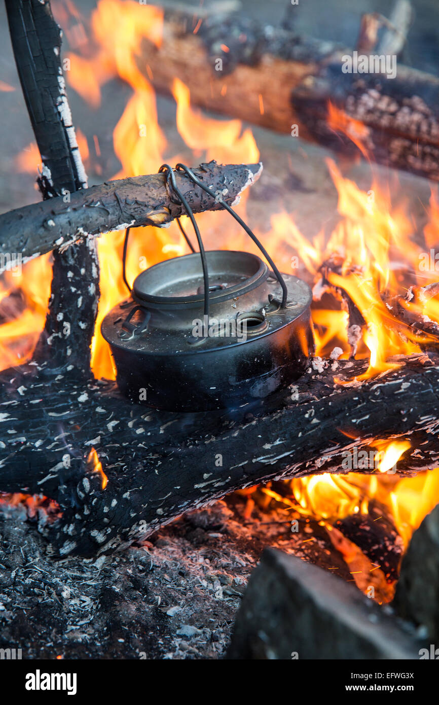 Making coffee at bonfire in the woods Stock Photo - Alamy