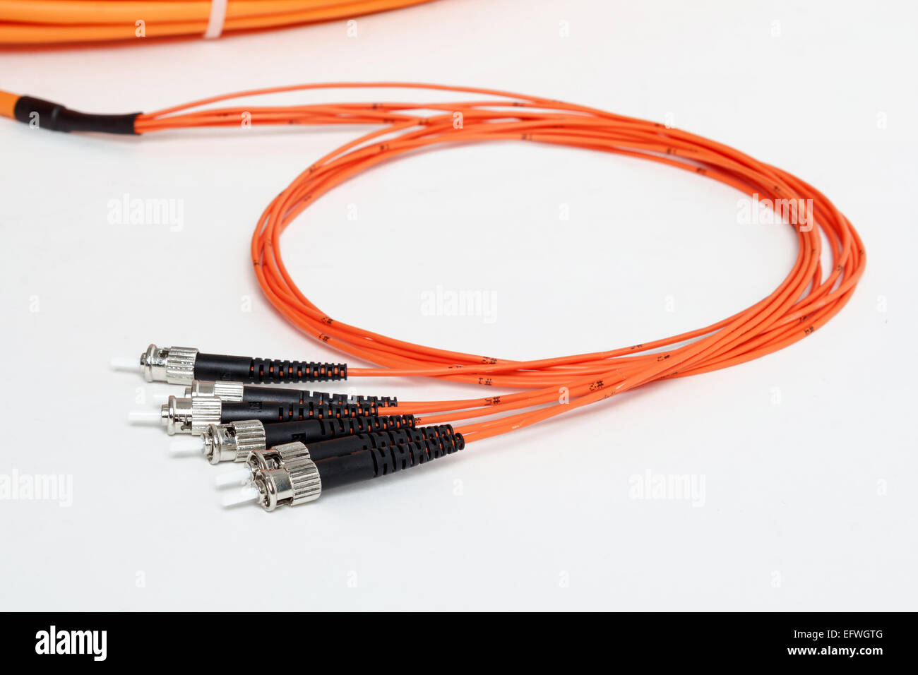 group of fiber optic ST connectors on orange patchcord Stock Photo - Alamy