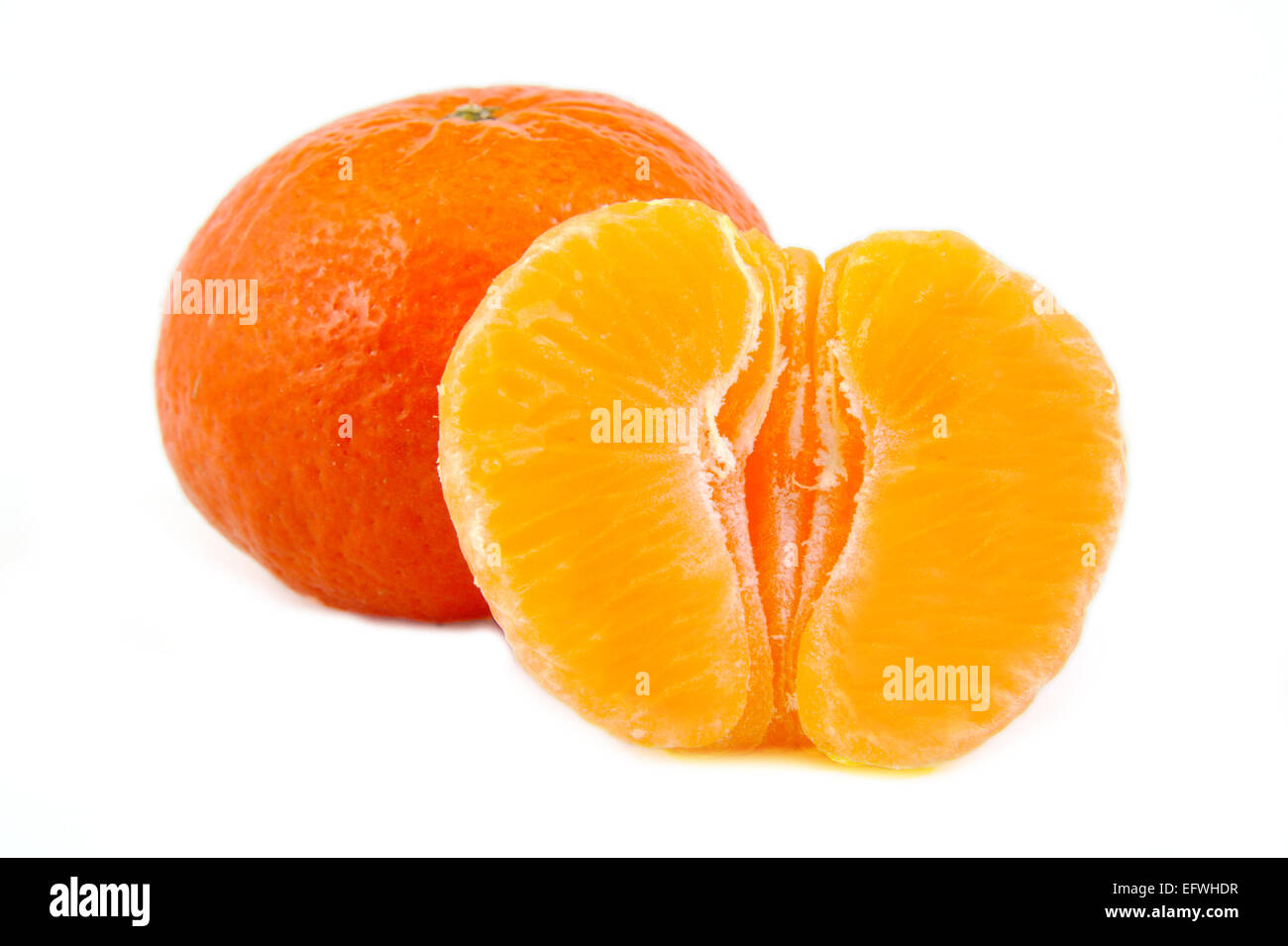 Closeup view of one and a half tangerine, orange fruit, citrus on white ...