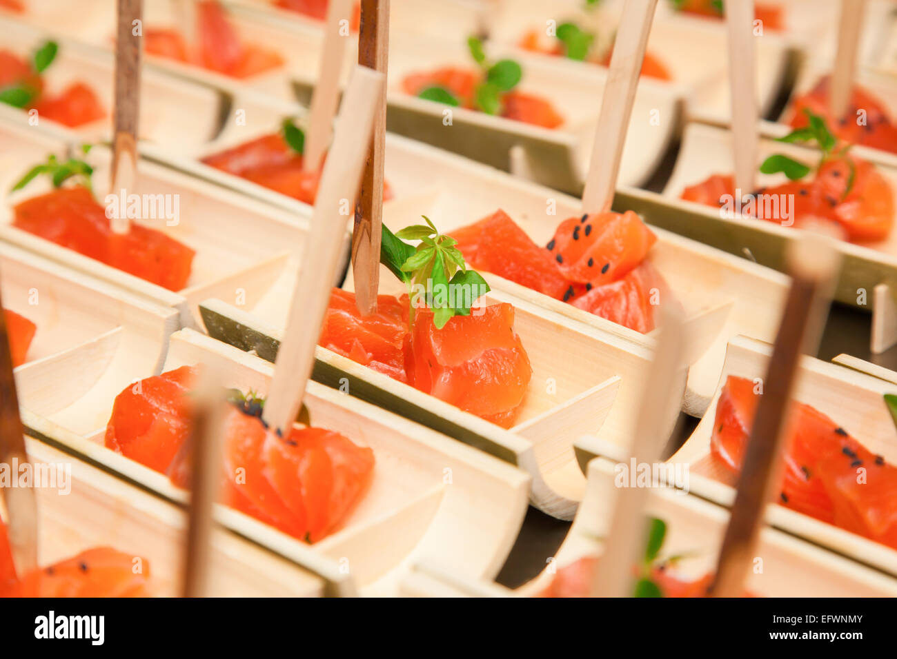 Raw salmon sushi meat cubes on black background Stock Photo - Alamy