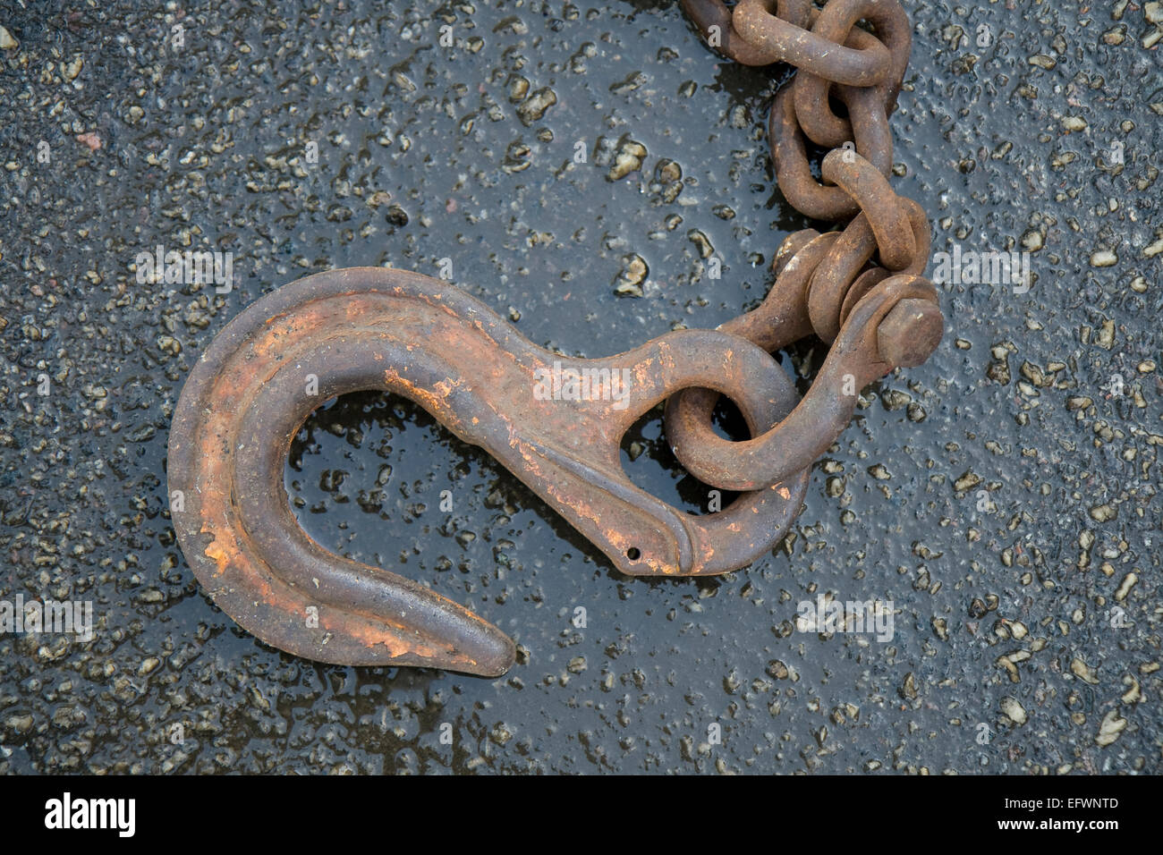 Rusty load hook on a background of asphalt Stock Photo - Alamy