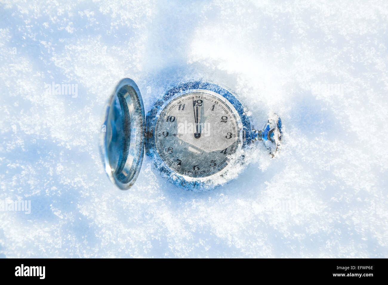 vintage watch covered with frost on the background of snow Stock Photo ...
