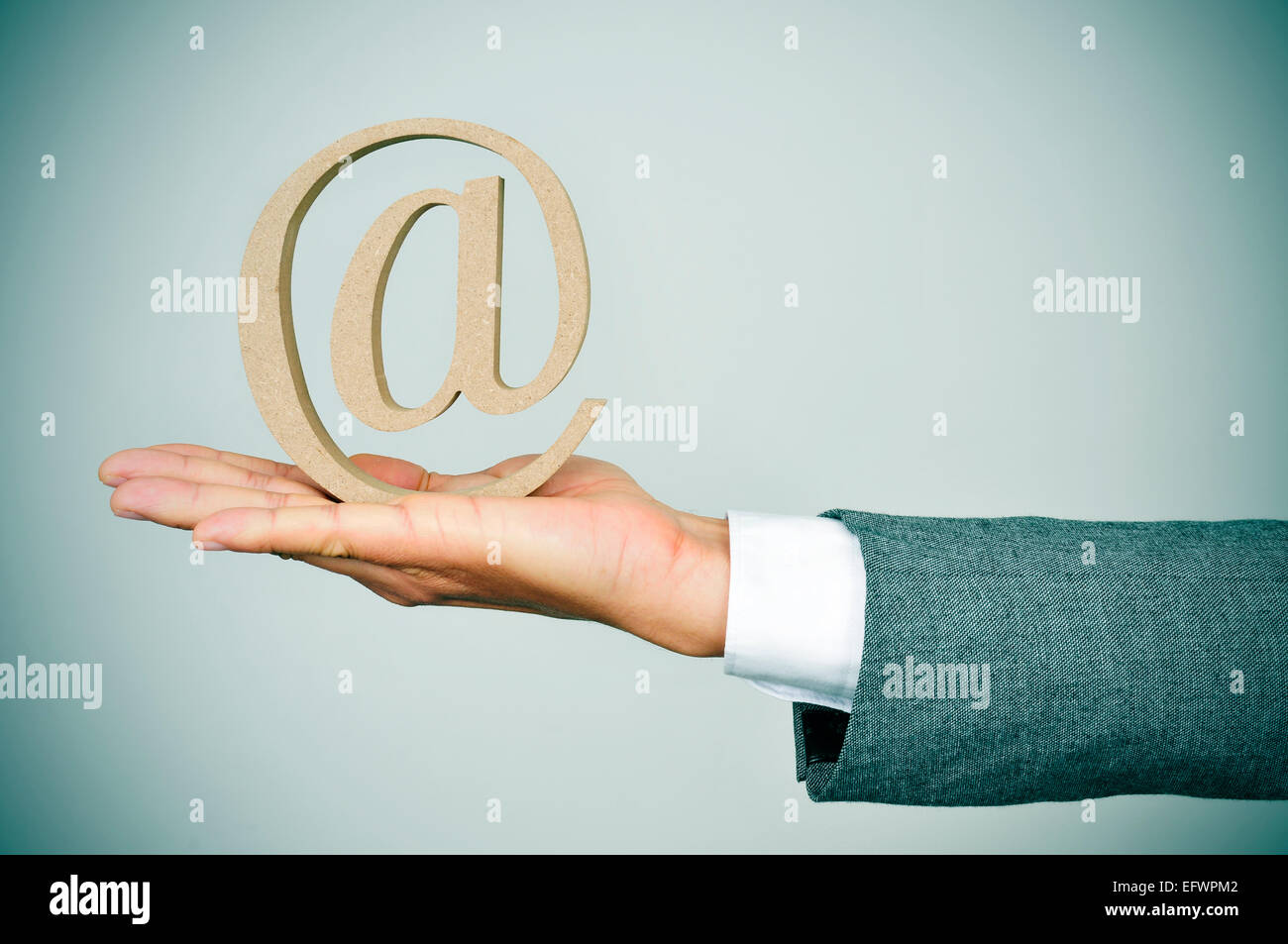 closeup of the hand of a young businessman showing an at sign Stock ...