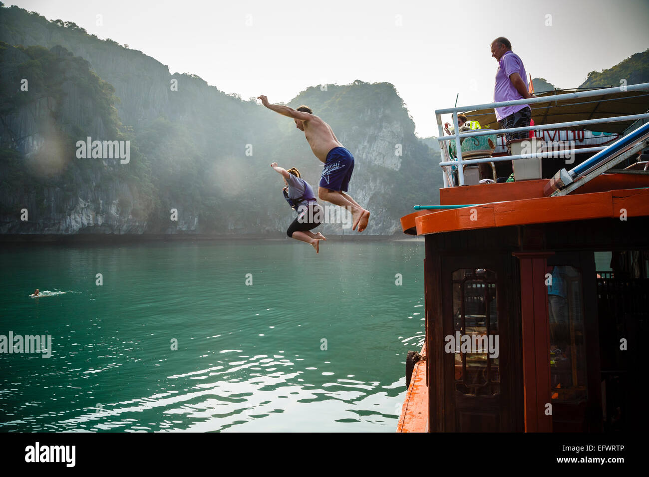 People jumping to the water from a boat at Halong Bay, Vietnam Stock ...