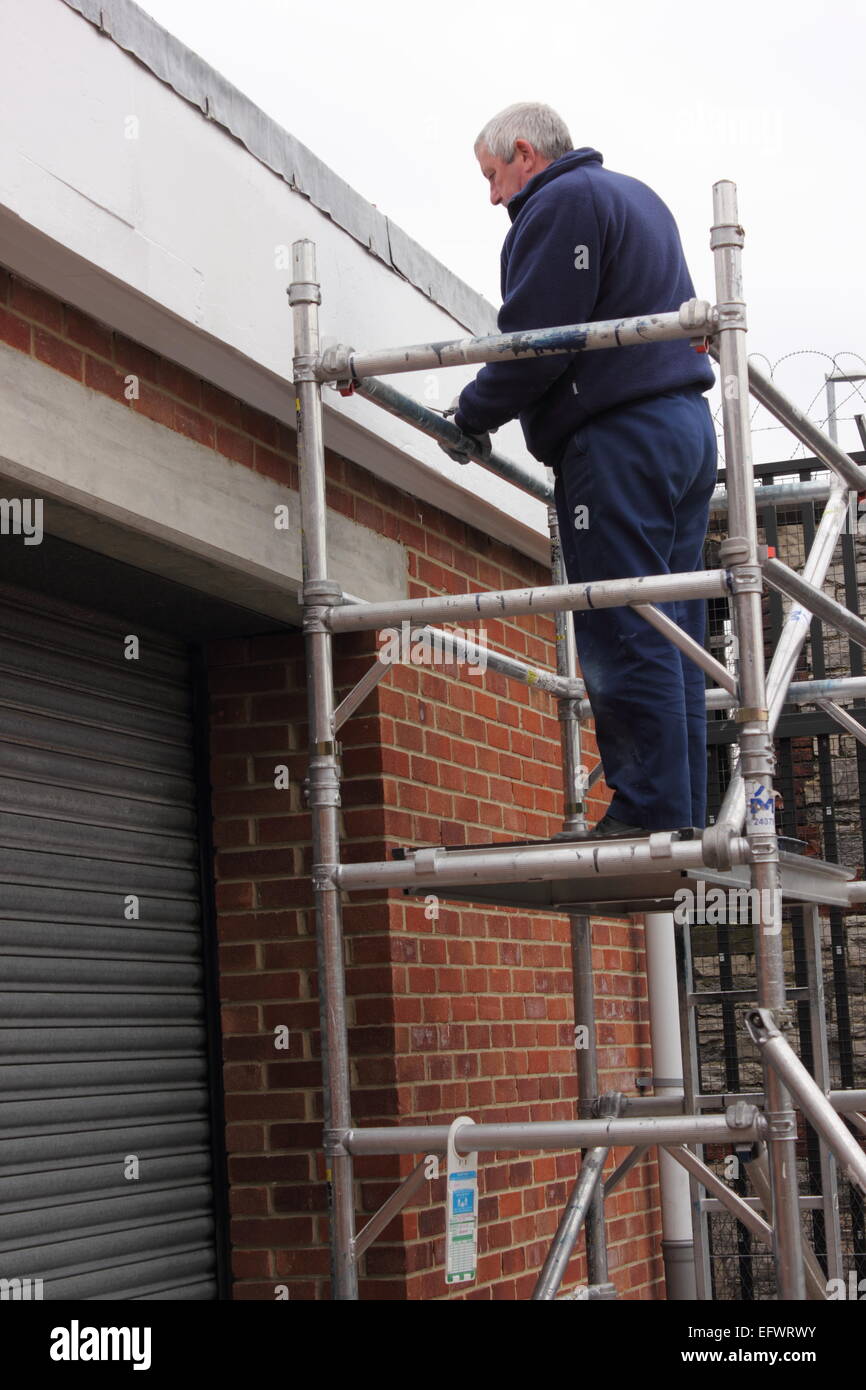 Working on scaffold tower Stock Photo - Alamy