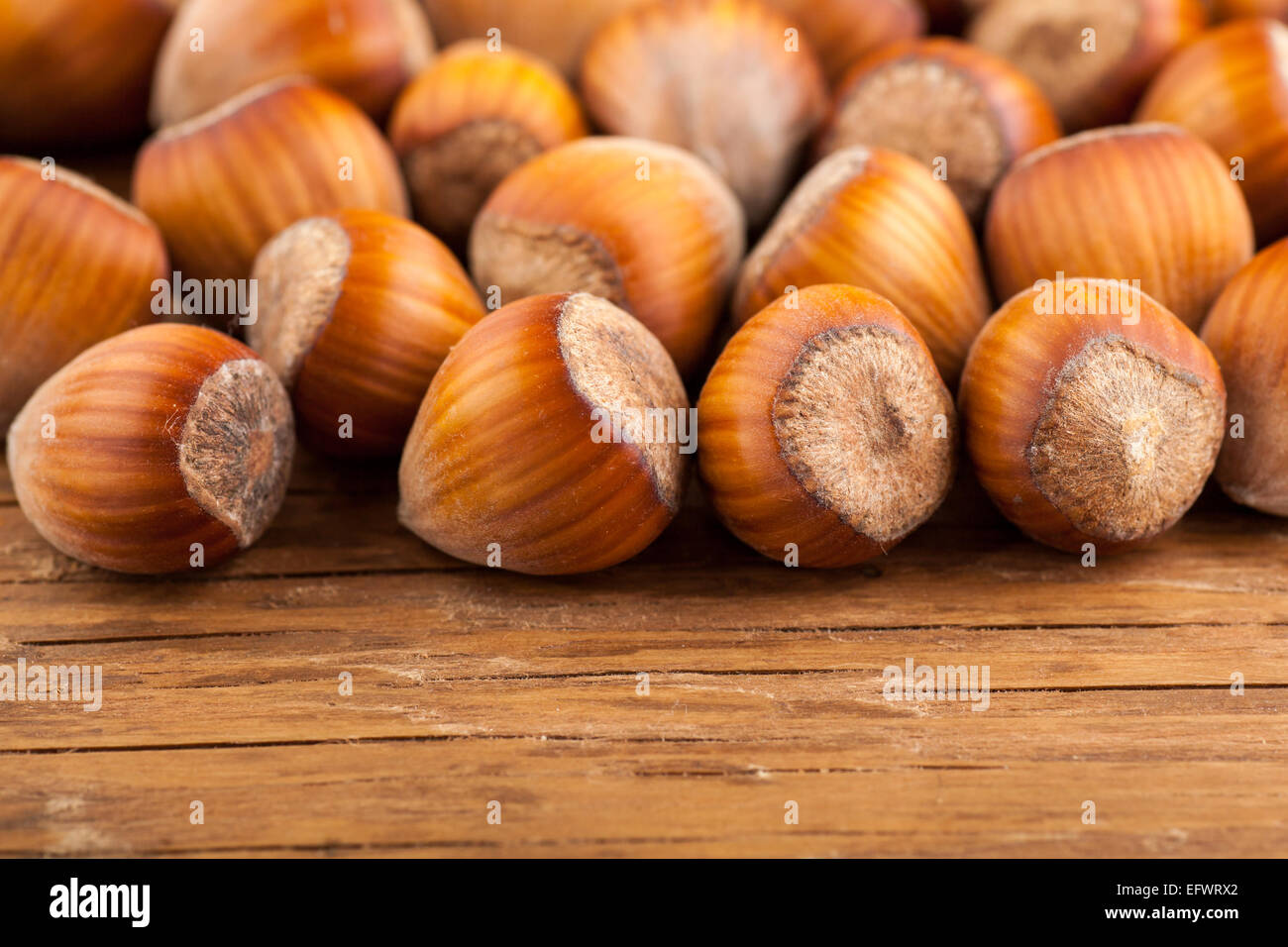 dried whole hazelnuts close-up on wooden background Stock Photo - Alamy