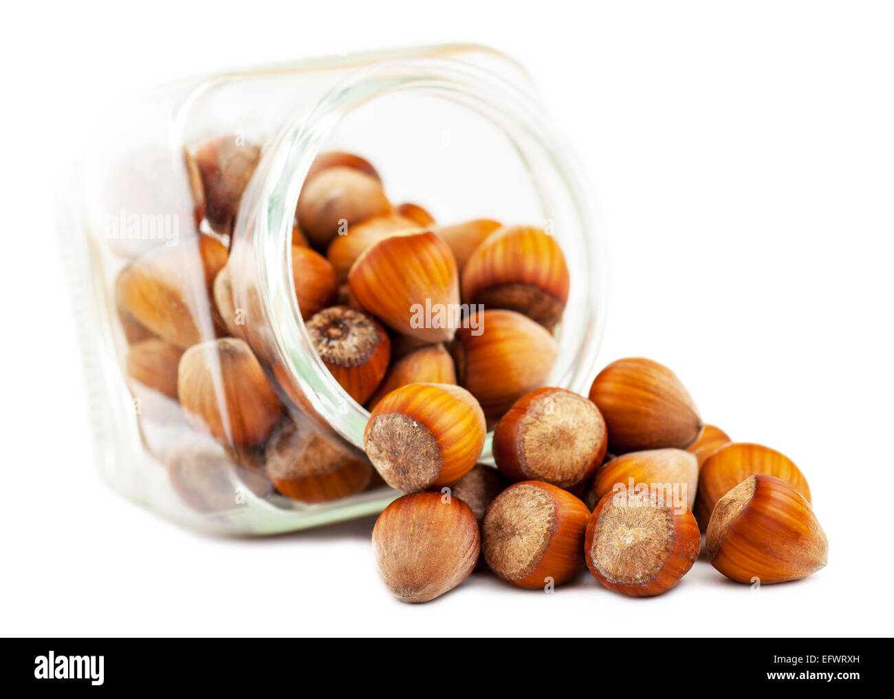 hazelnuts in a glass jar isolated on white background Stock Photo - Alamy