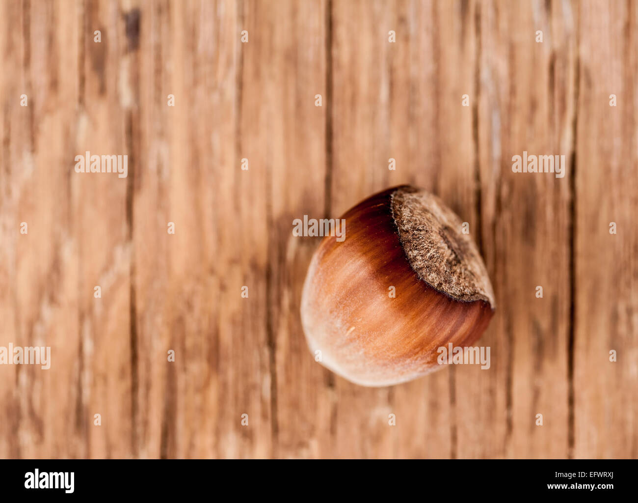 whole wood nut close-up on wooden background Stock Photo - Alamy