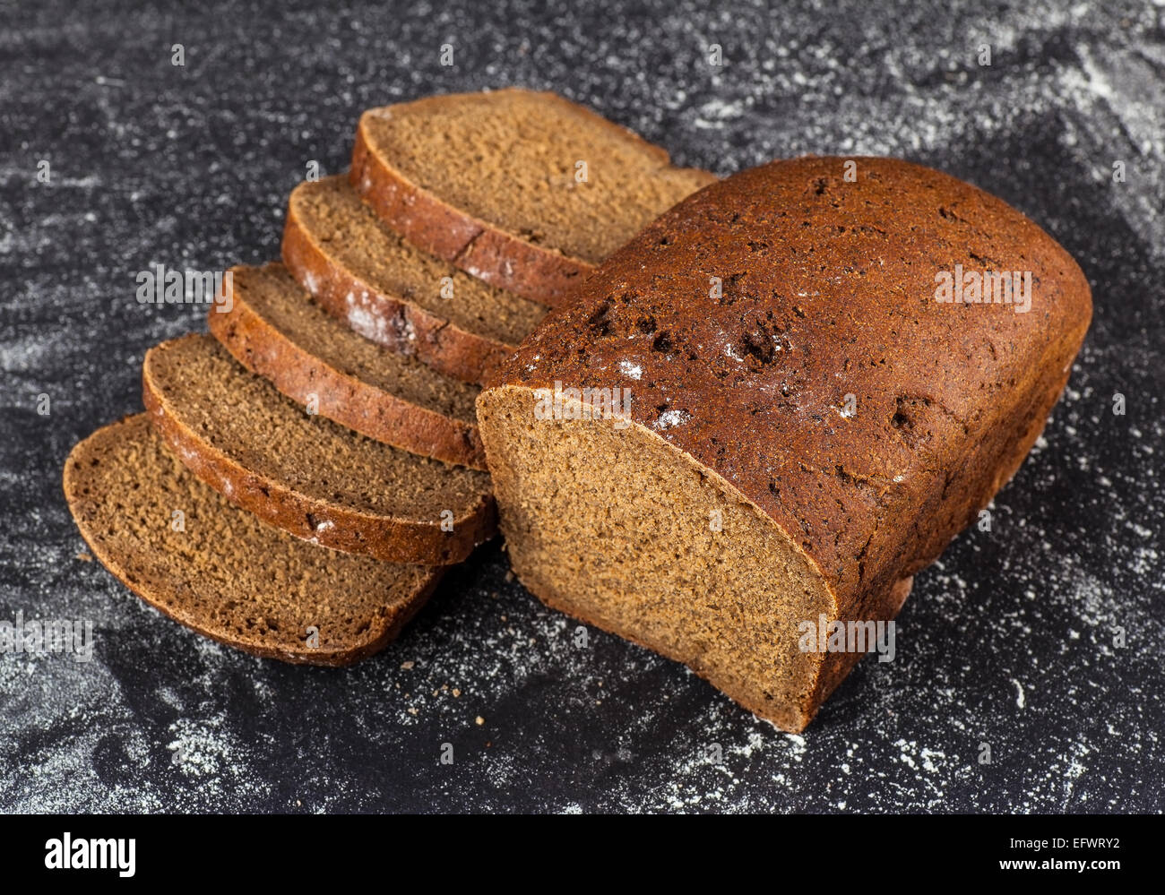 sliced loaf rye bread on a dark background Stock Photo - Alamy