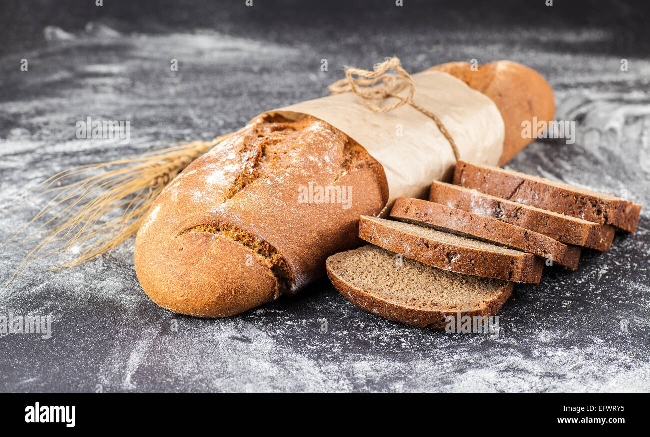 sliced bread on a dark background with flour Stock Photo - Alamy