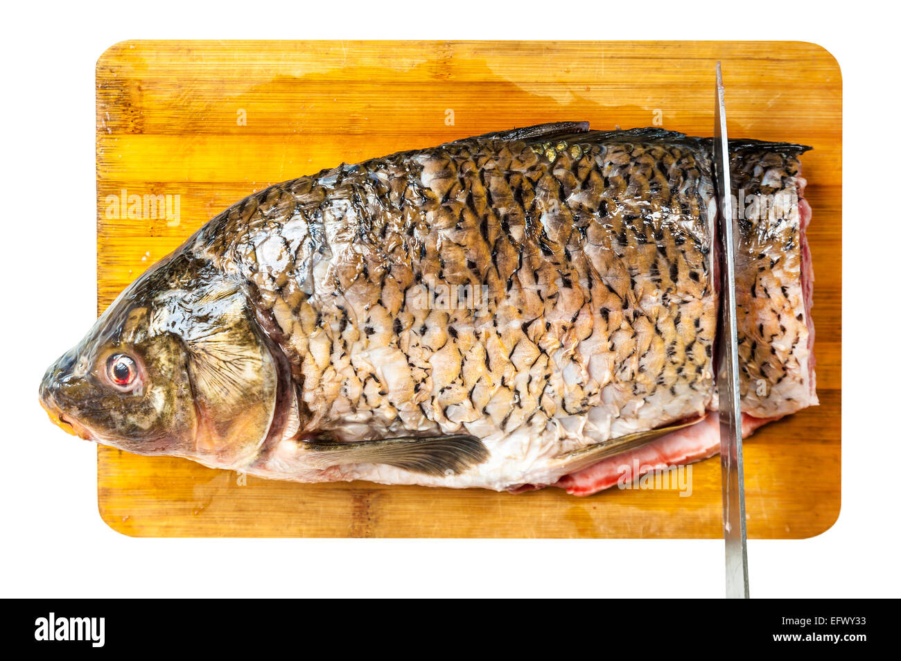 cleaned fish lying on a wooden board with knife Stock Photo - Alamy