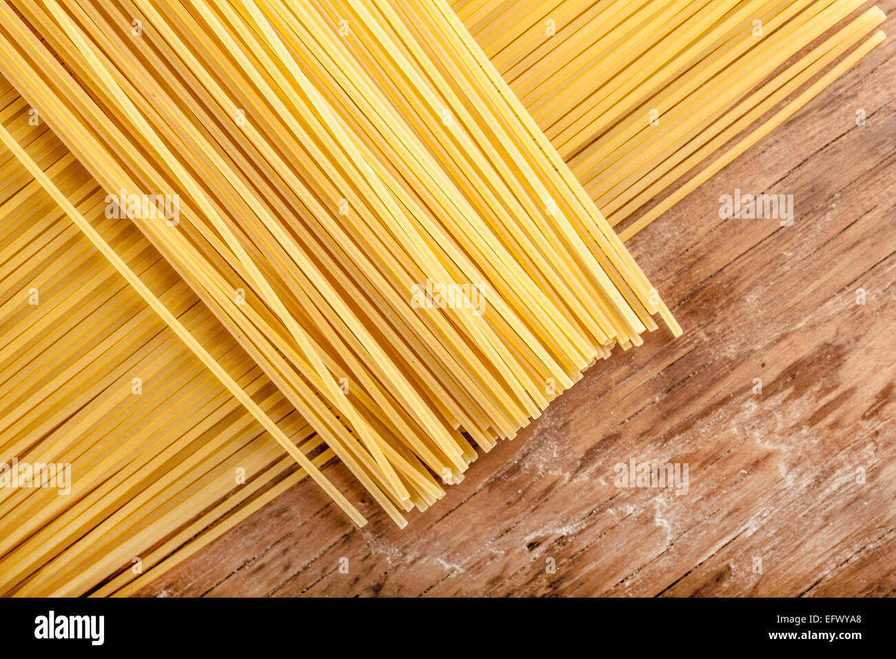 pasta lined up in a row on a wooden background Stock Photo - Alamy