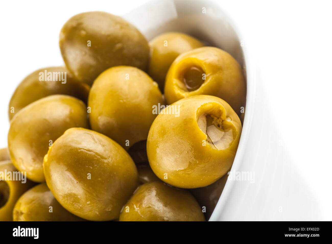 stuffed green olives marinated in a plate closeup Stock Photo - Alamy