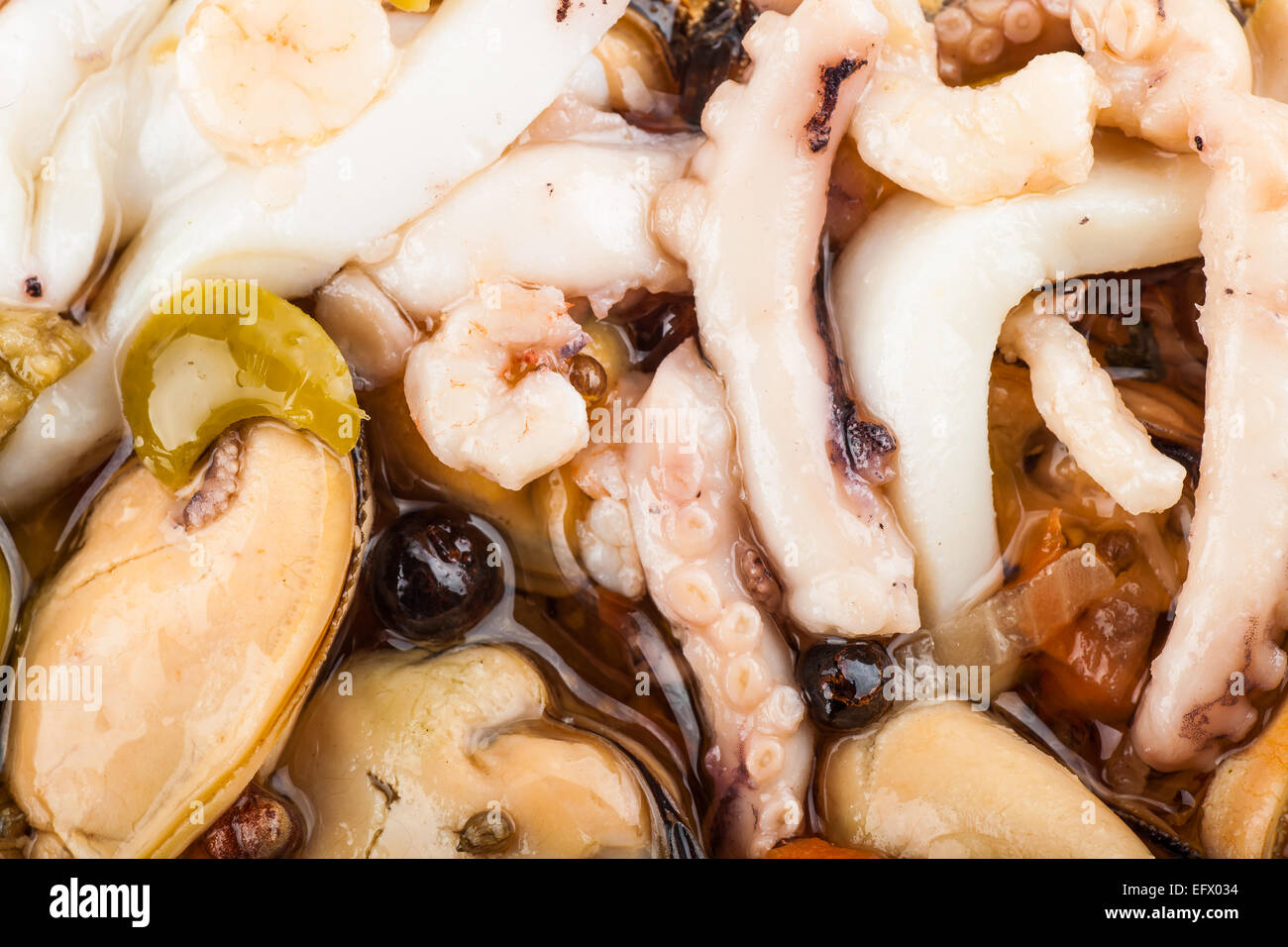 background mix of seafood in brine with spices closeup Stock Photo - Alamy