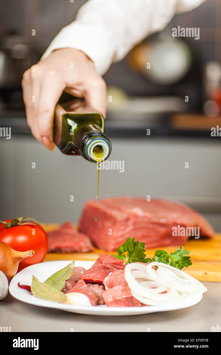 Chef pours olive oil on beef fillet Stock Photo - Alamy