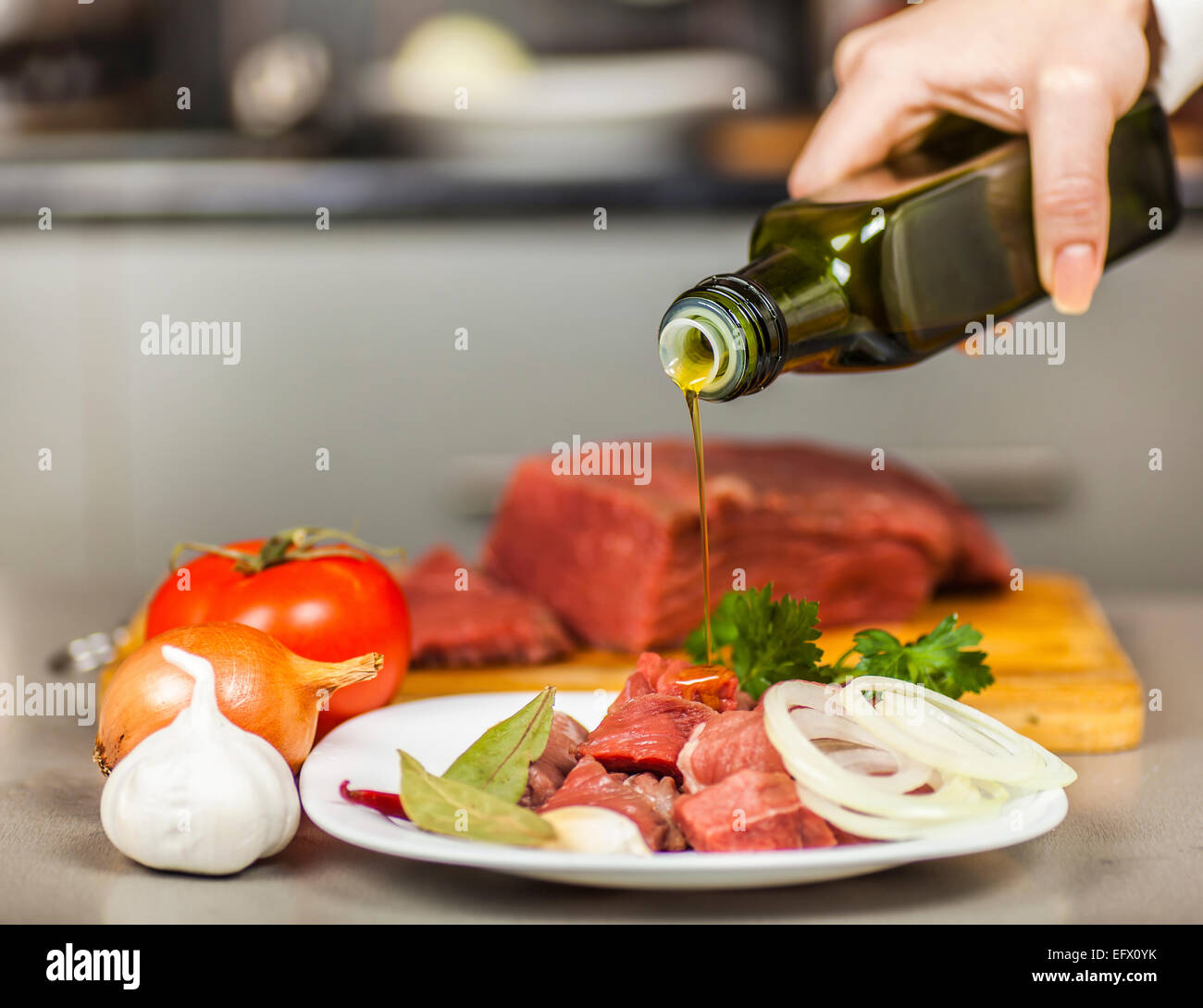 Chef pours olive oil on meat fillet Stock Photo - Alamy